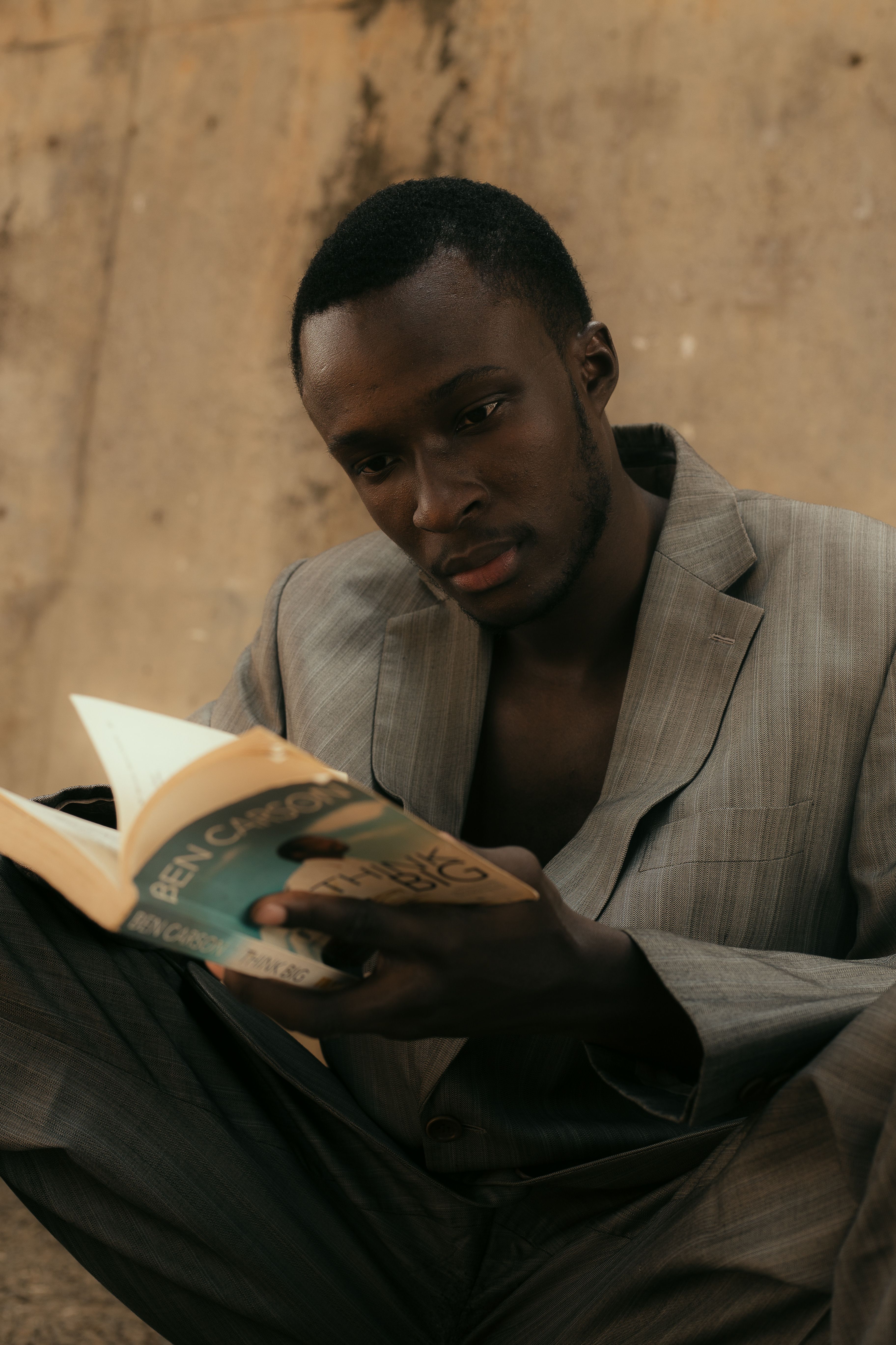 A man reading a book in a suit · Free Stock Photo