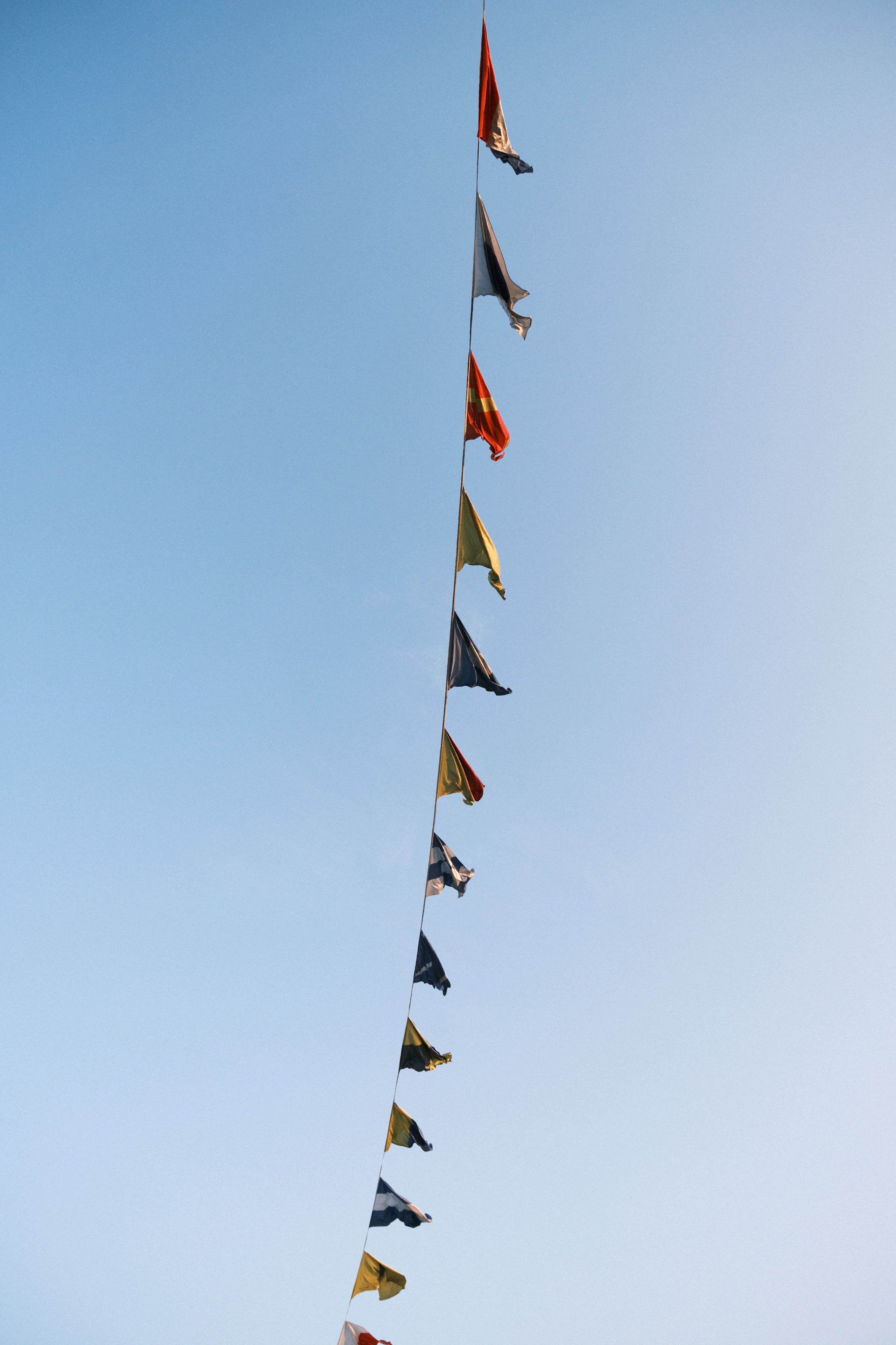A group of flags flying in the sky · Free Stock Photo
