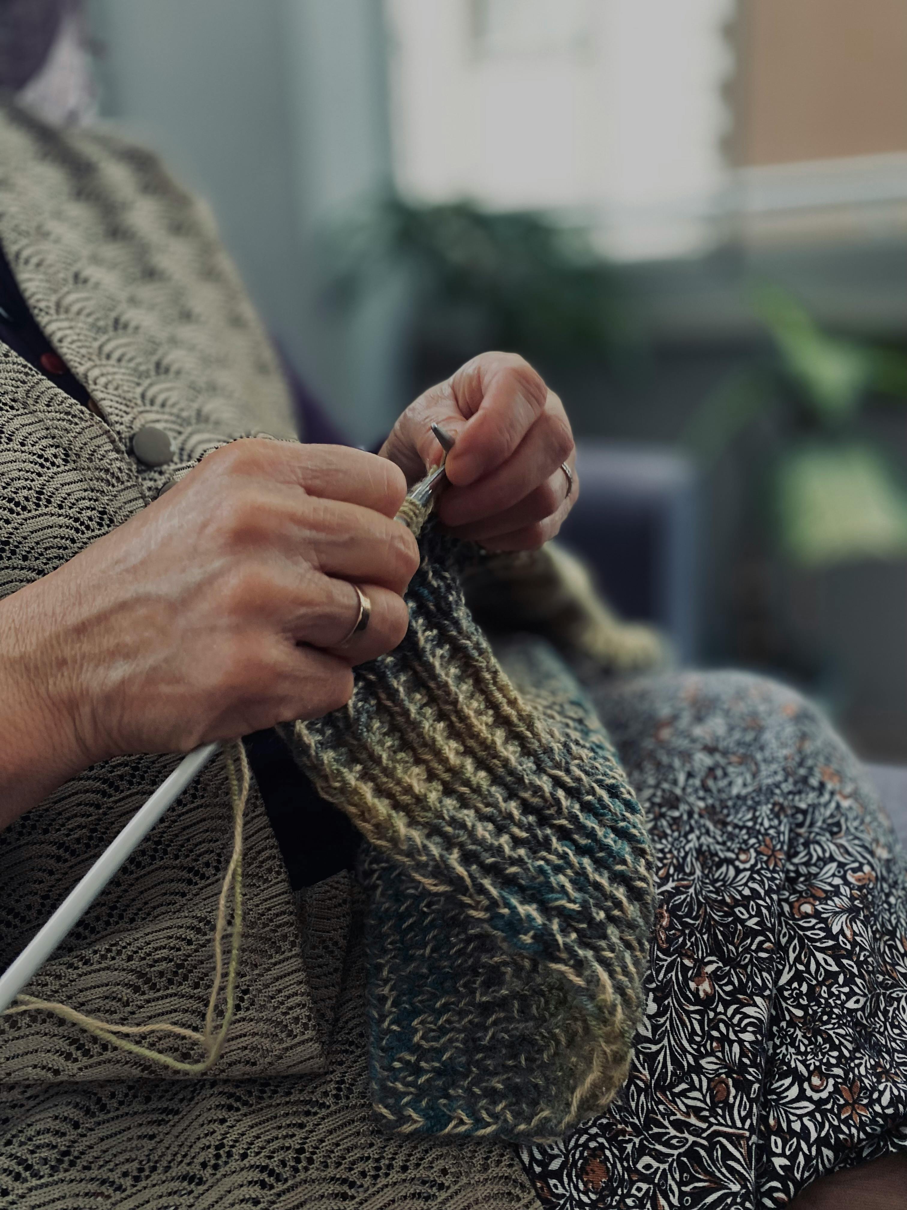 Close-up of an Elderly Woman Sitting and Knitting · Free Stock Photo