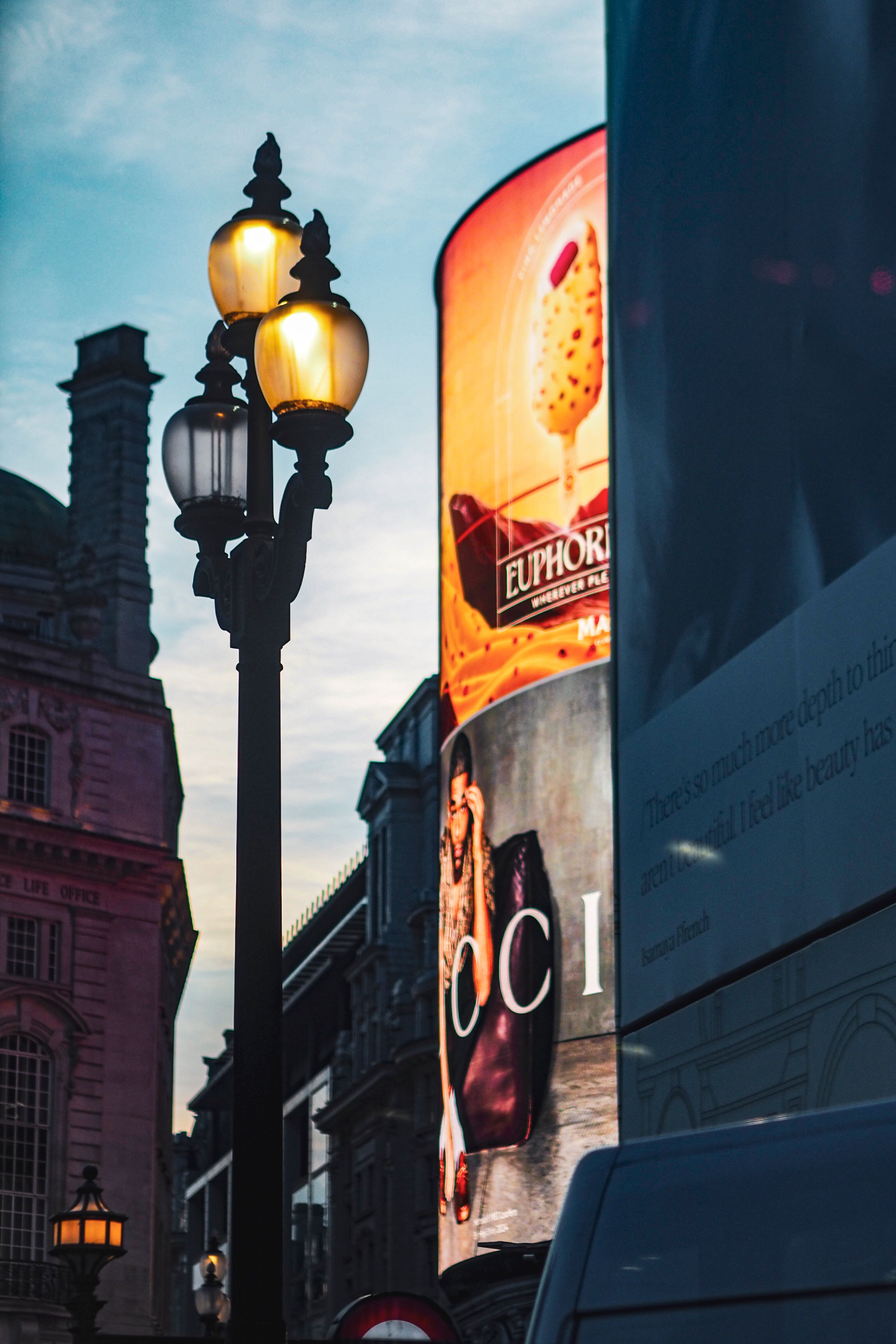 A street lamp and a billboard on a street · Free Stock Photo