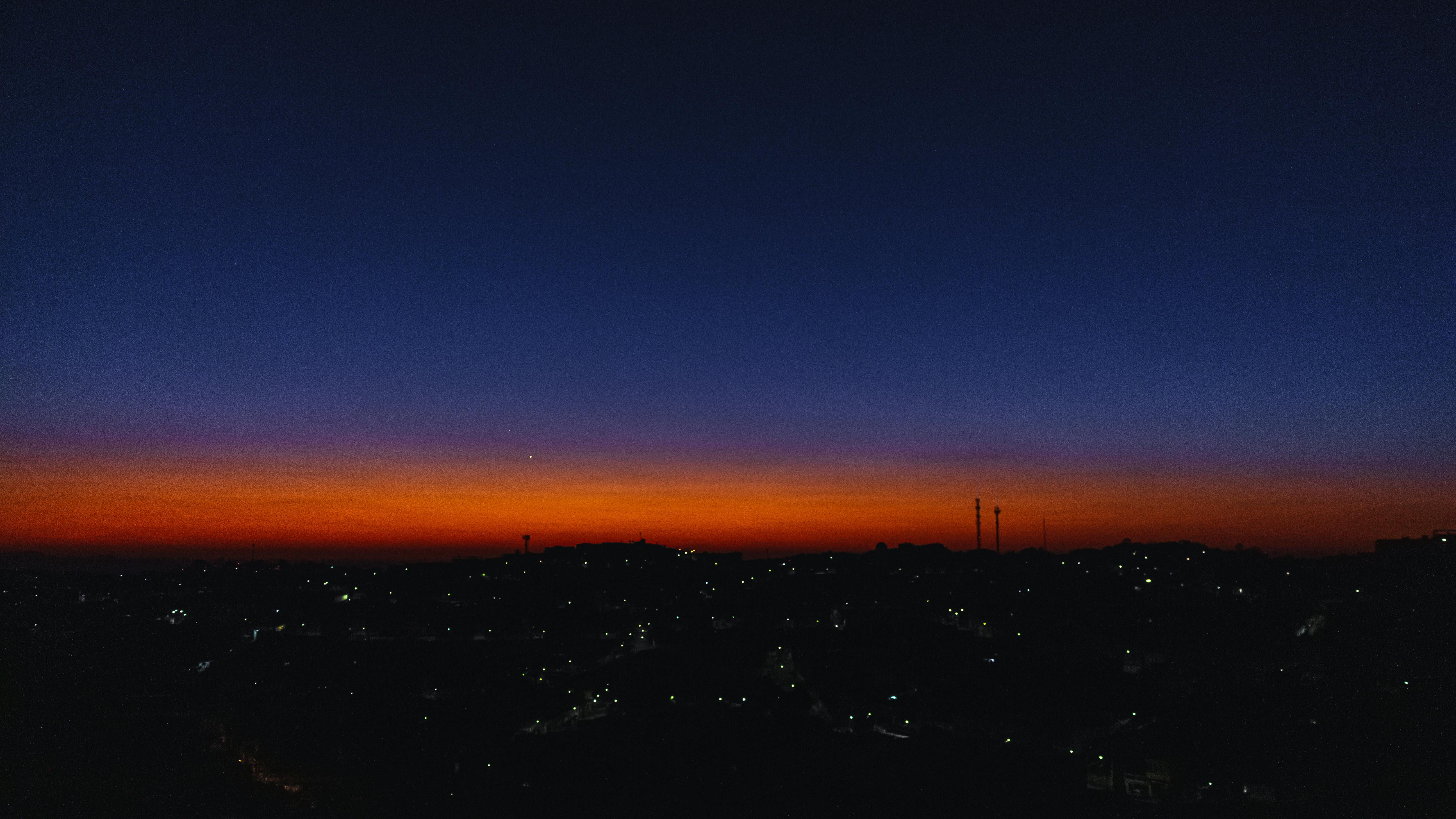 City Under Orange Sky at Night Time · Free Stock Photo