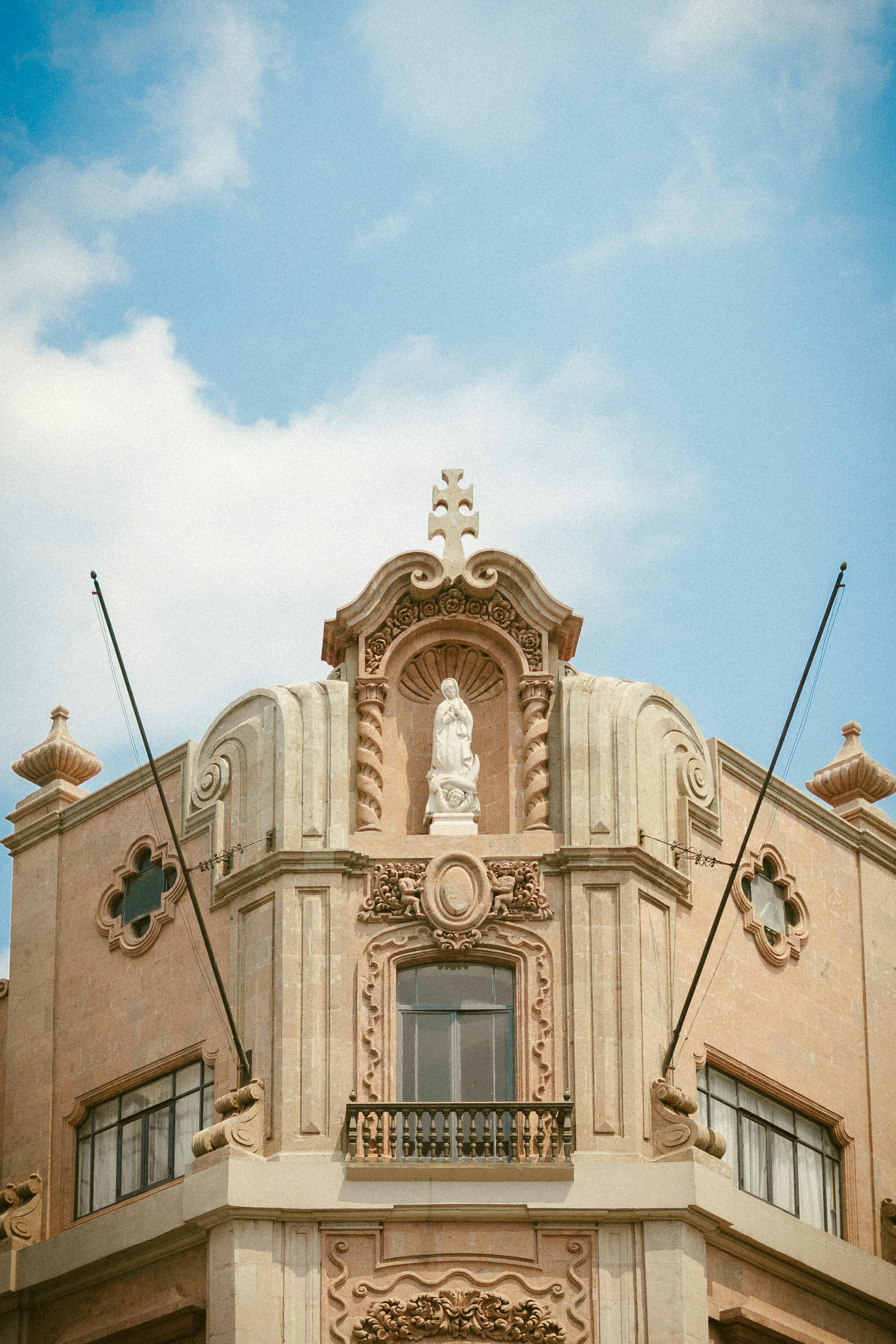 Sculpture on Building Wall · Free Stock Photo