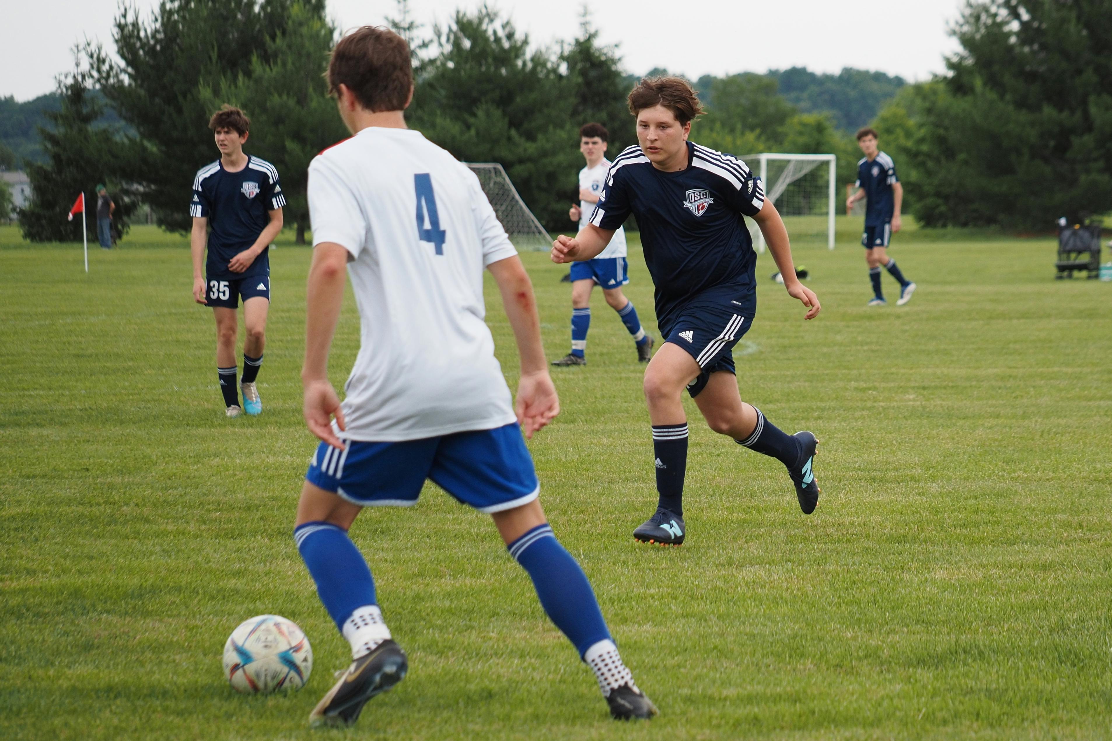 Three Men Playing Soccer · Free Stock Photo