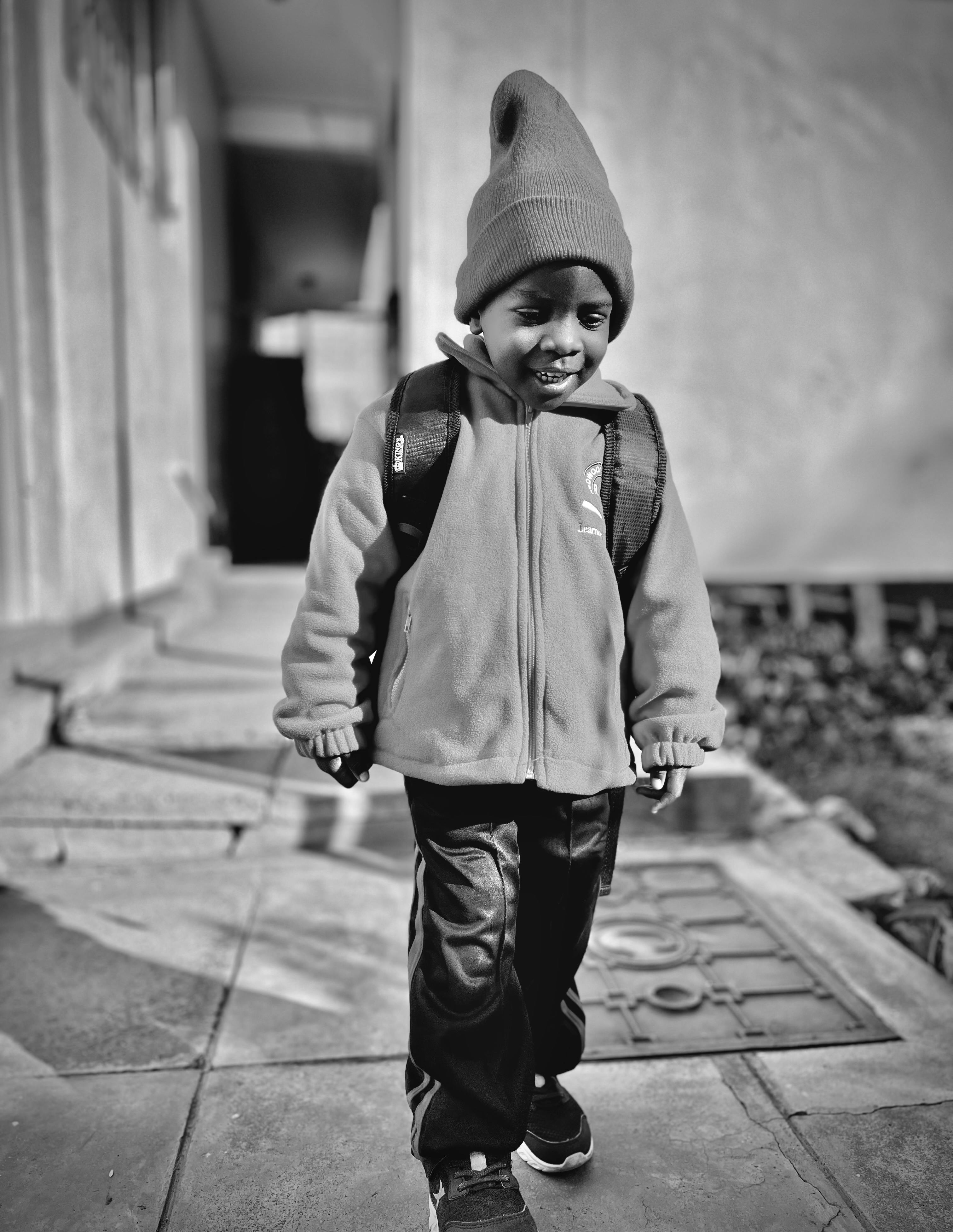 Cute little kid standing on stony ground with pebbles in hand · Free ...