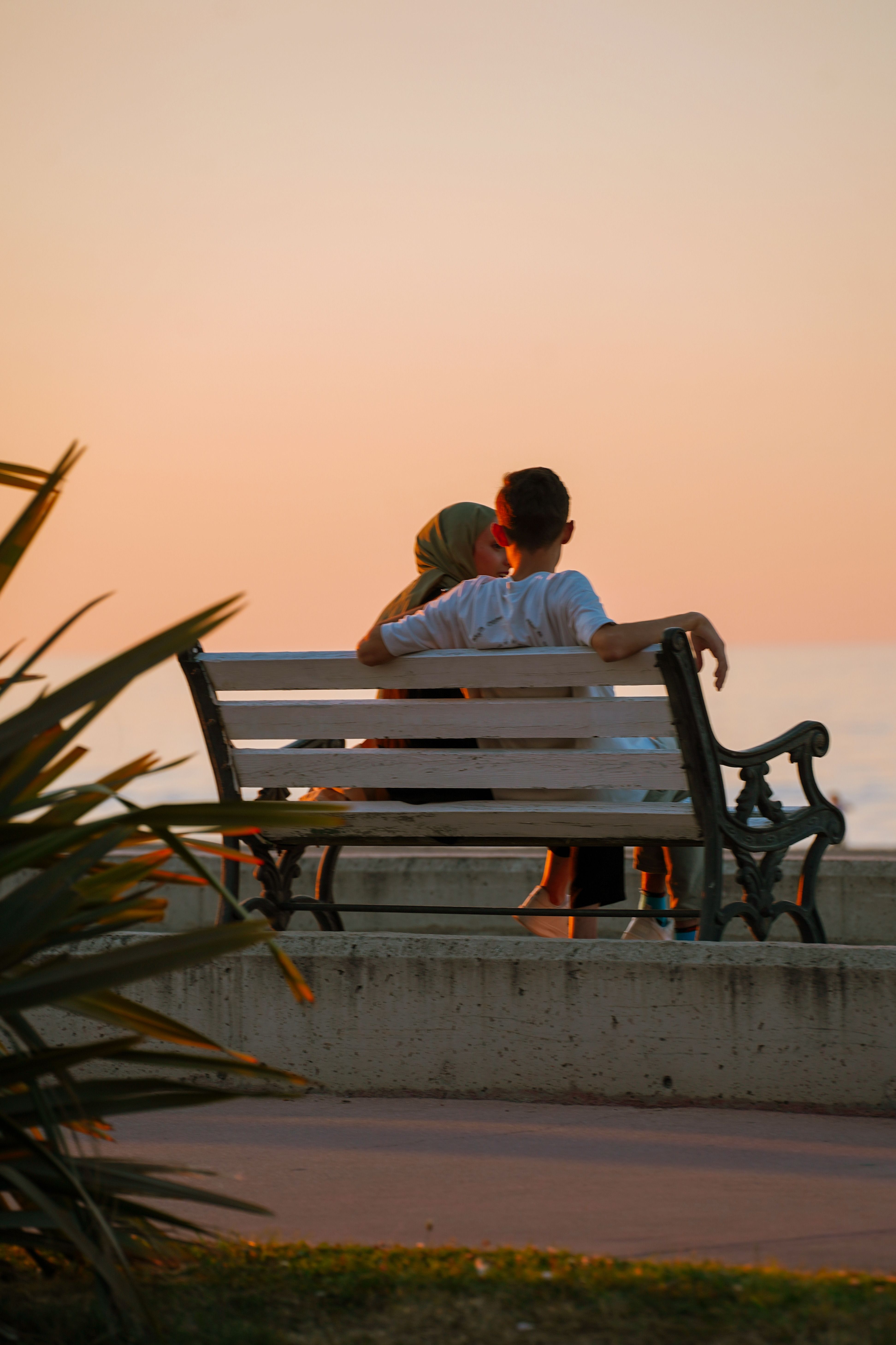 Couple Sitting on Bench on Promenade on Sea Shore at Sunset · Free ...
