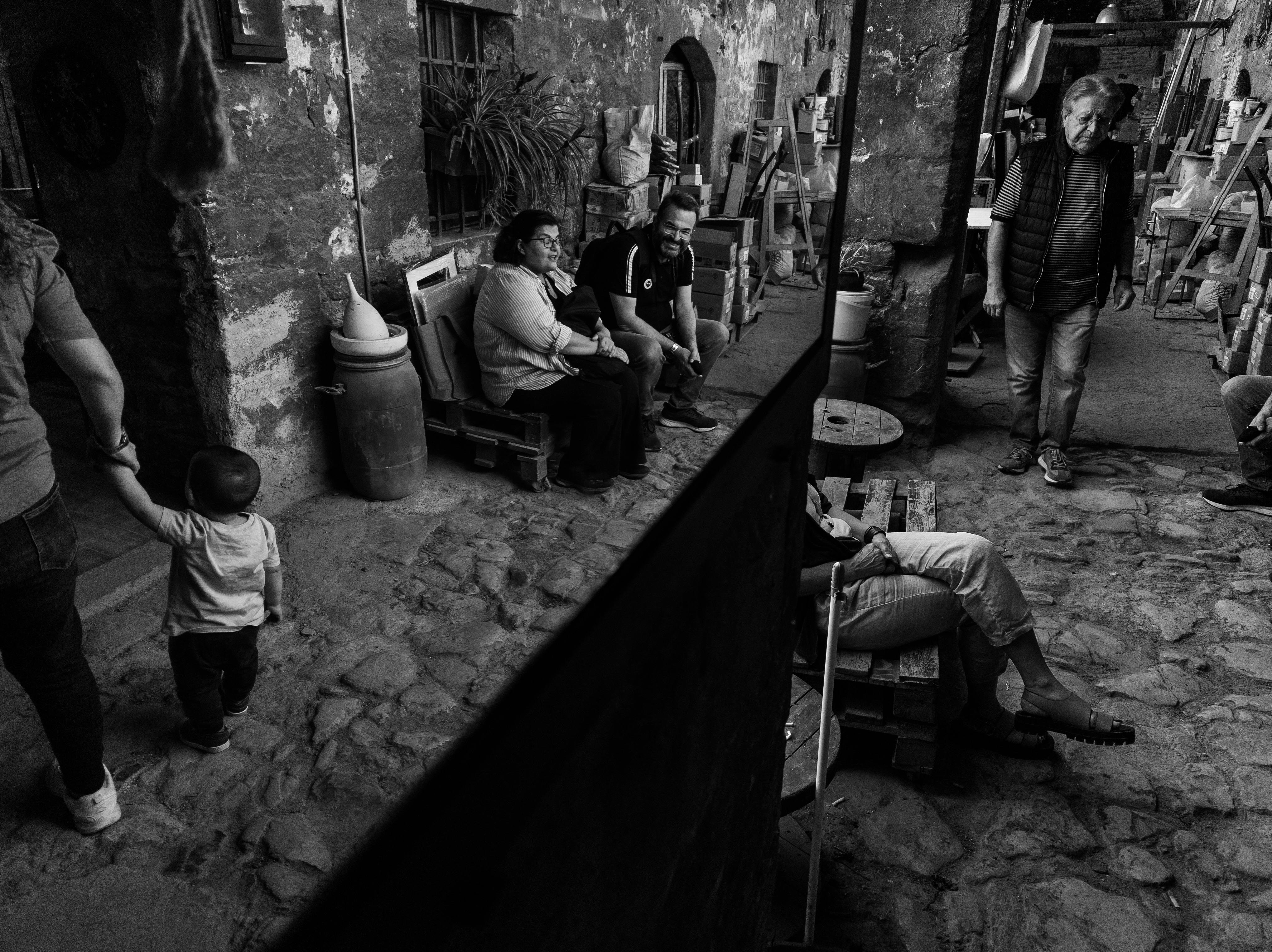 Sitting on Sidewalk Smiling Couple Mirroring in Mirror · Free Stock Photo