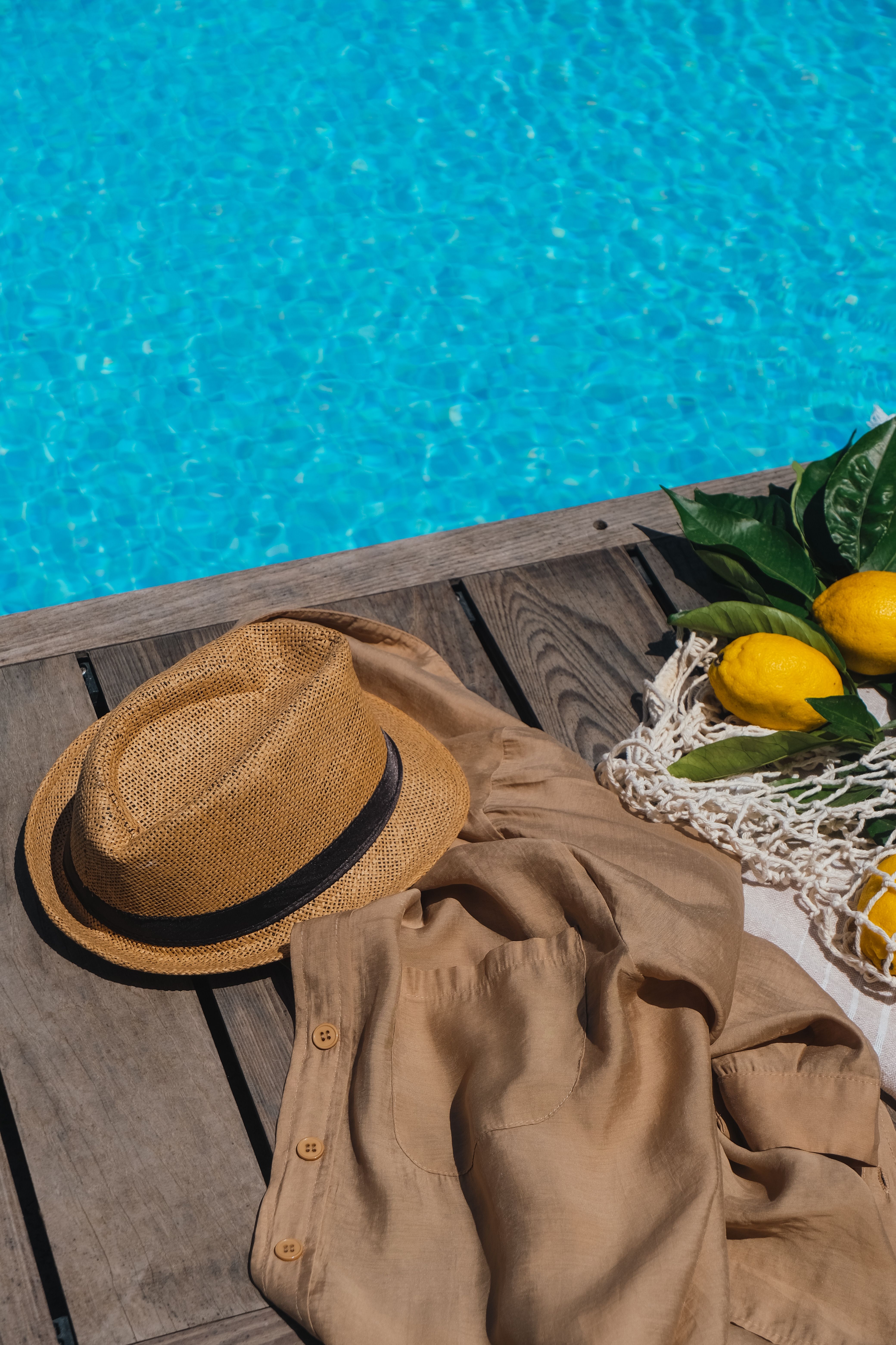 Clothes by a Swimming Pool · Free Stock Photo