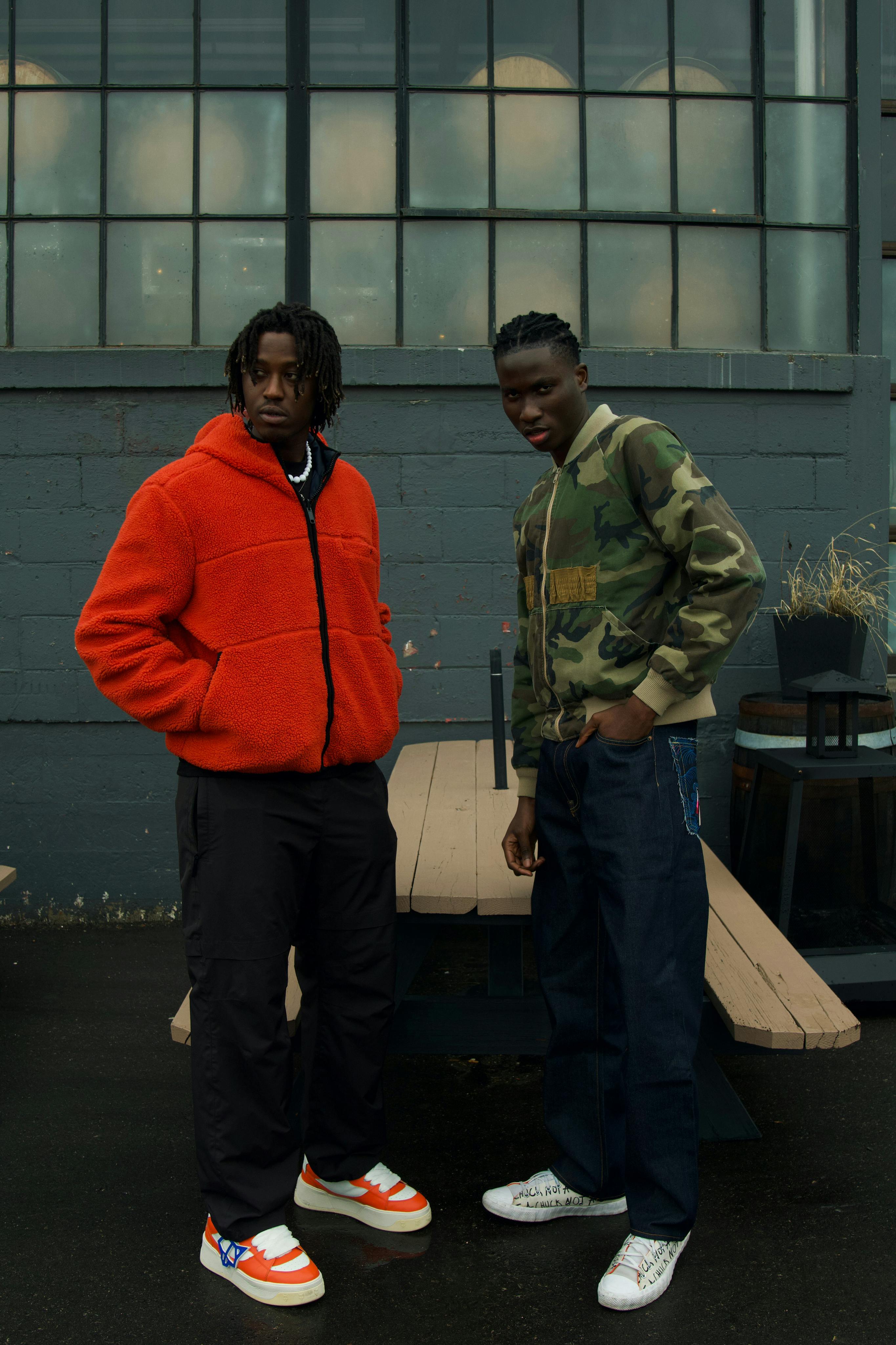 Two Young Men in Streetwear Outfits Standing near a Building · Free ...