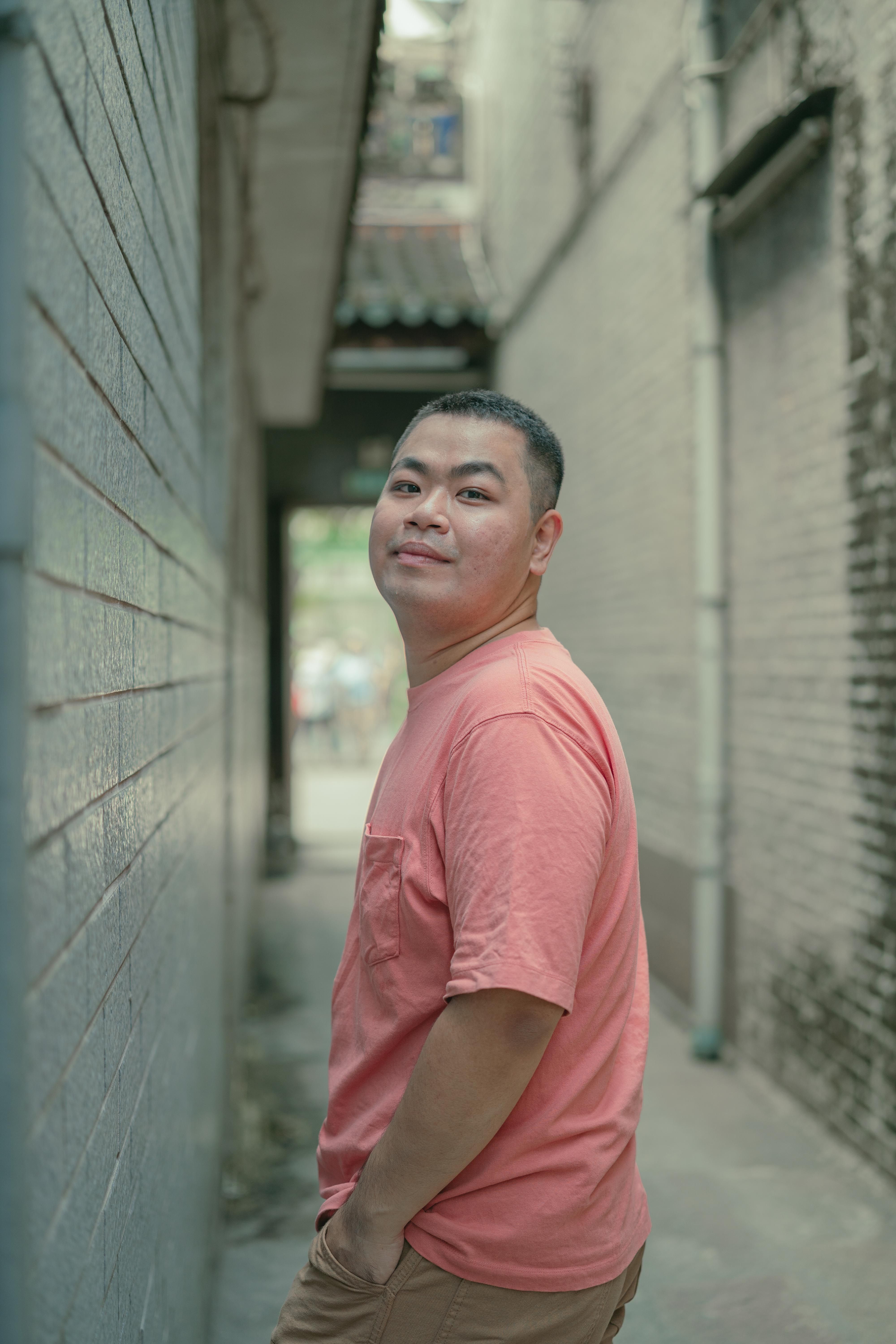 Man Standing in Narrow Alley · Free Stock Photo