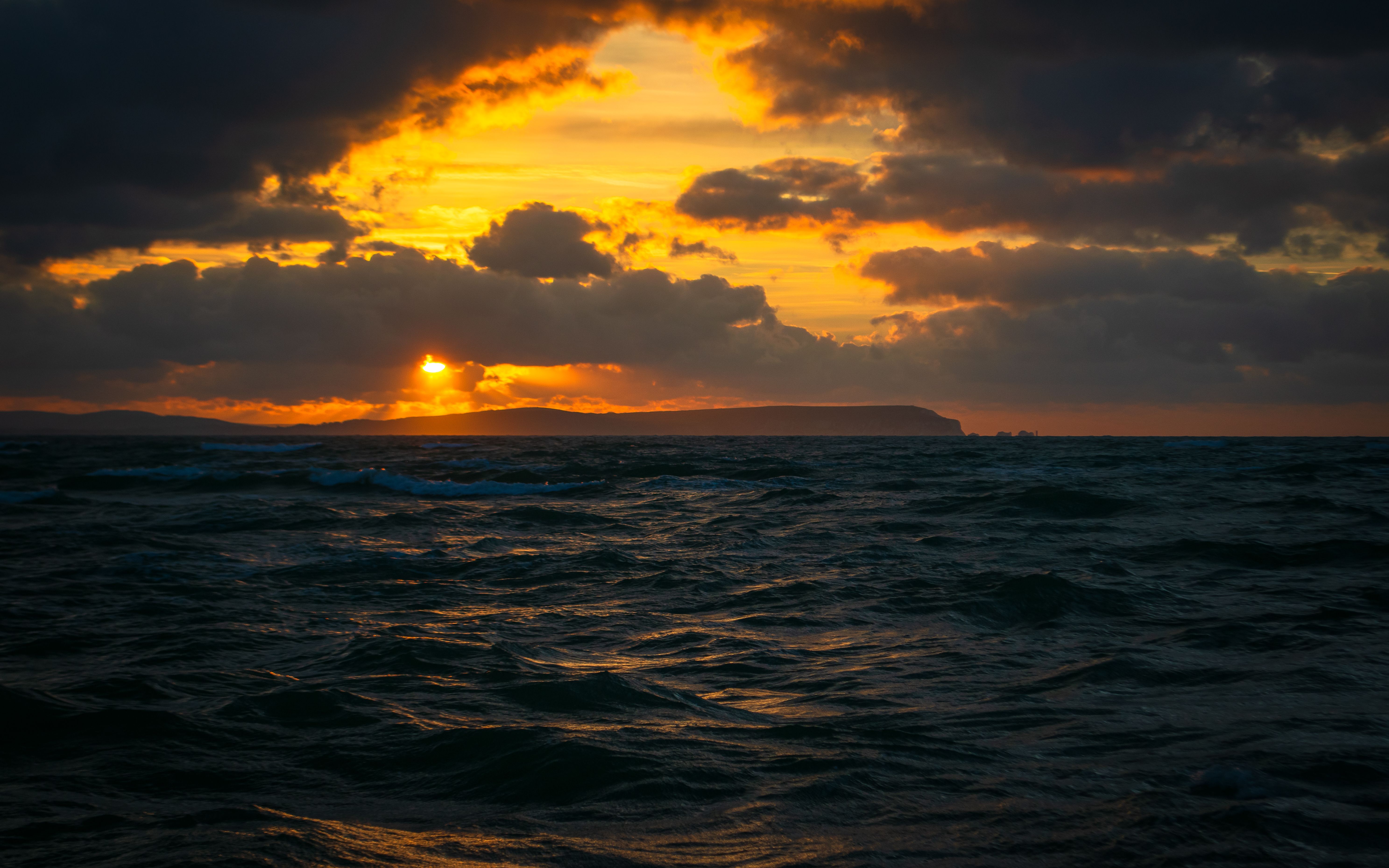 Sunset Over an Island in the Ocean · Free Stock Photo