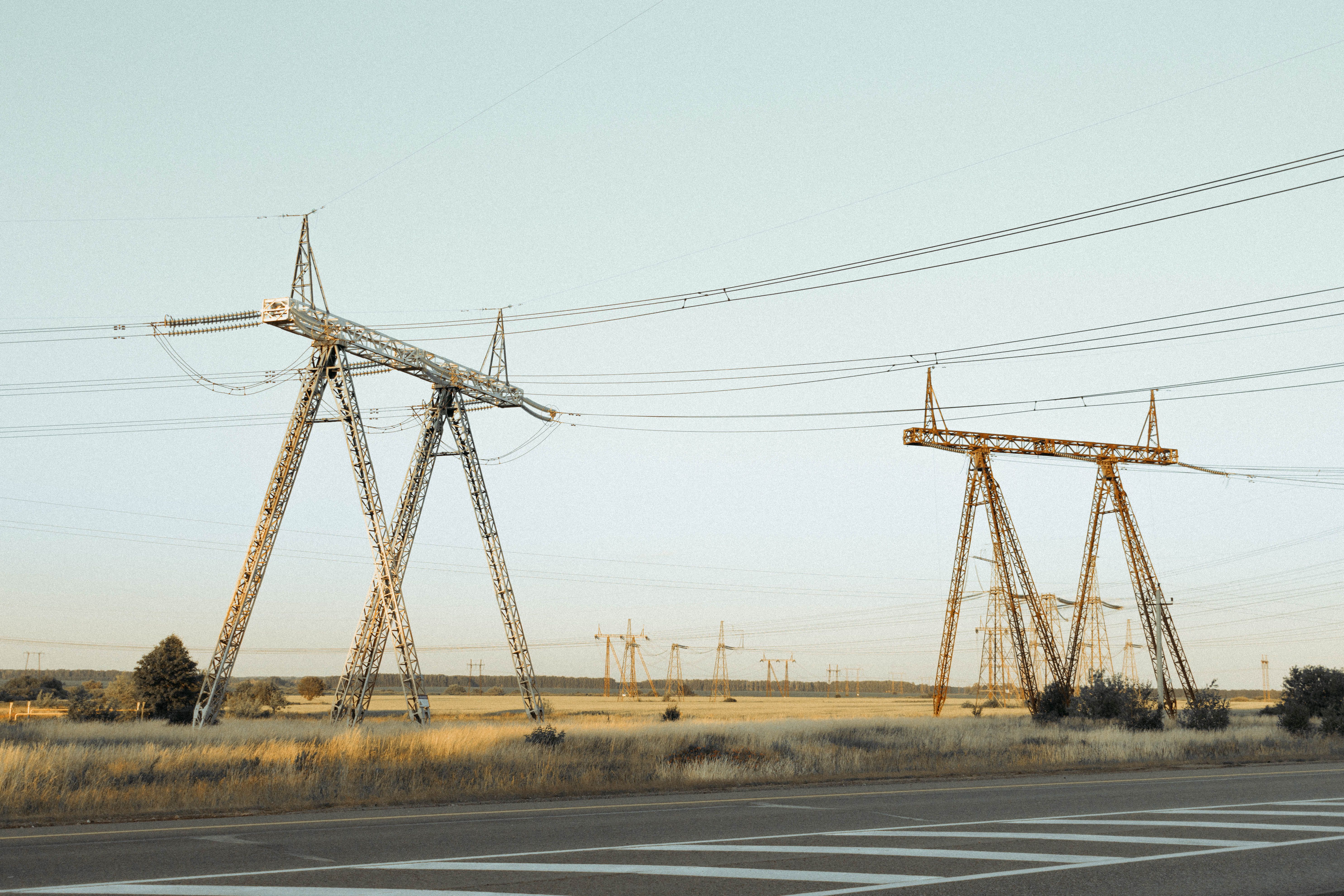 Electricity Pylons along a Country Road · Free Stock Photo