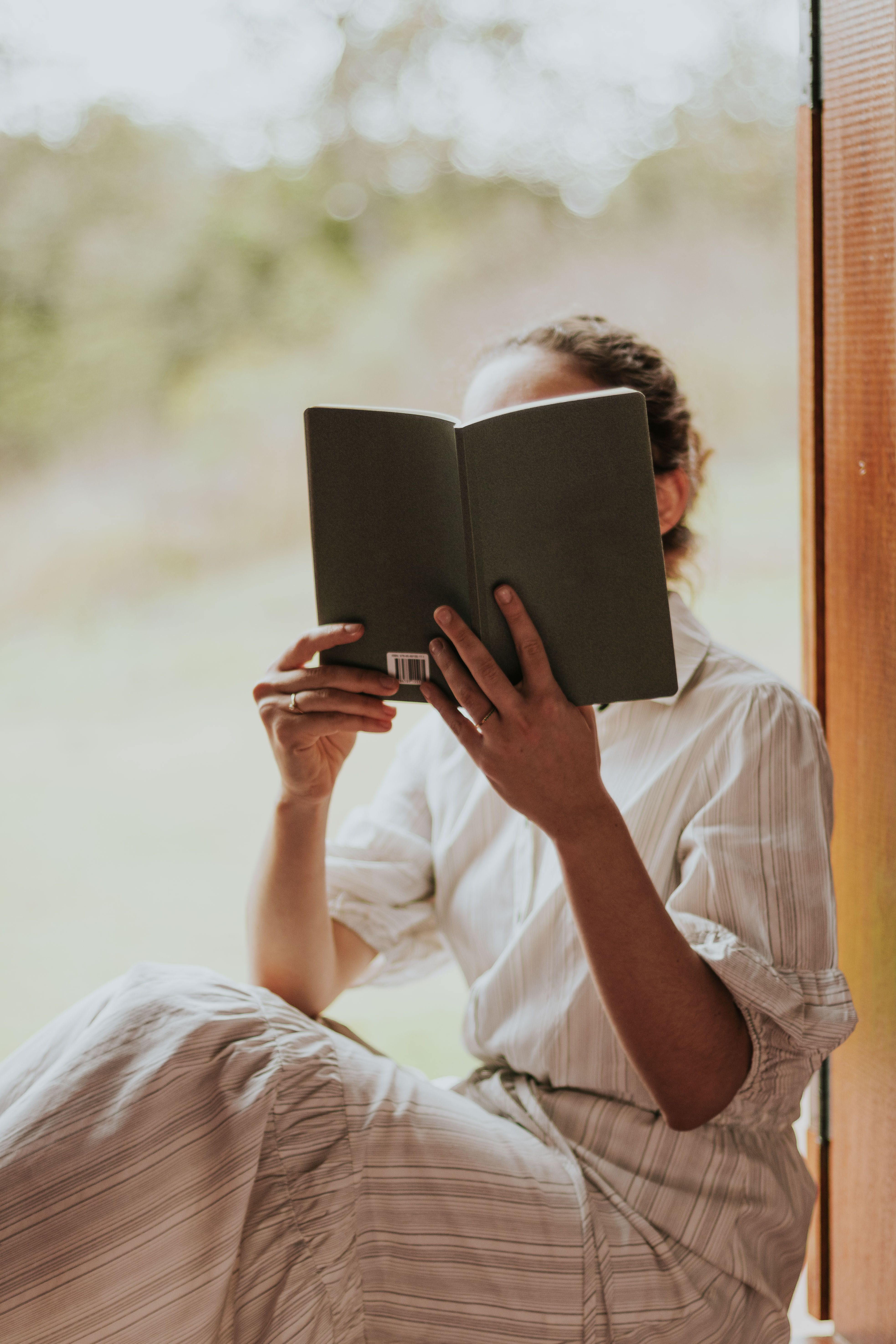 Person Laying on Sofa While Reading Book · Free Stock Photo