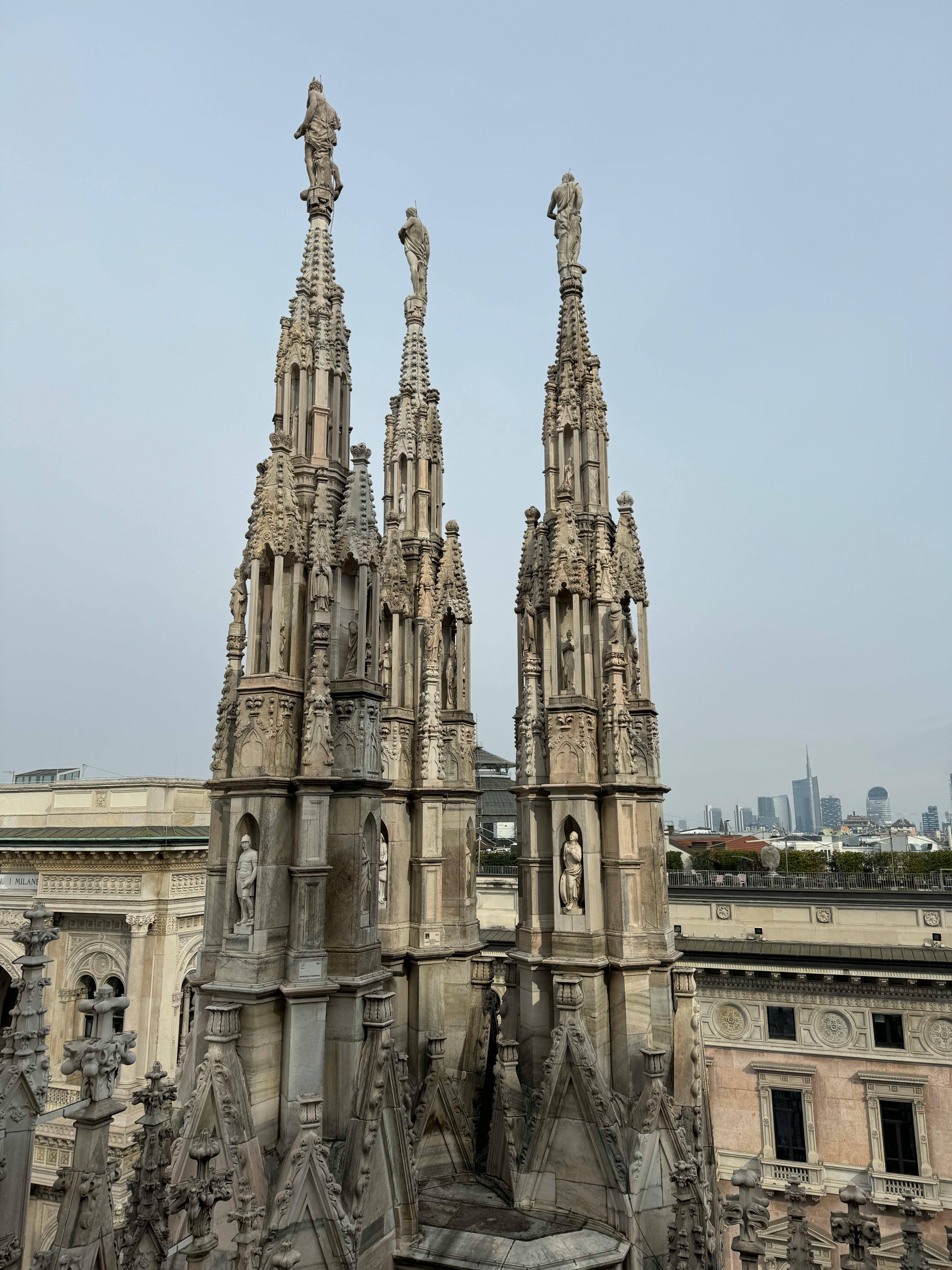 Carved spires of medieval cathedral against cloudy sky · Free Stock Photo