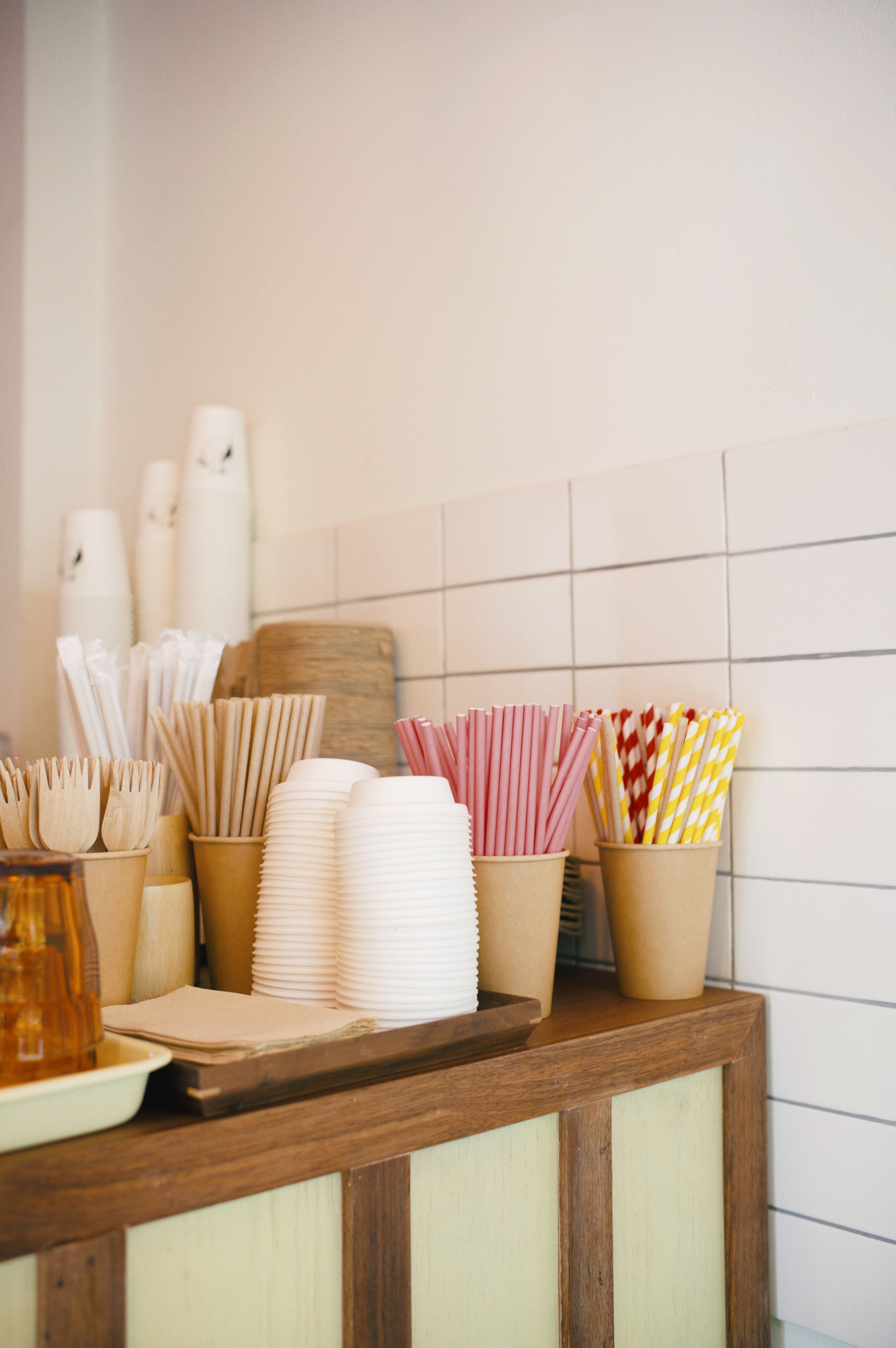 Paper Cups and Bowls with Forks and Straws on Table · Free Stock Photo