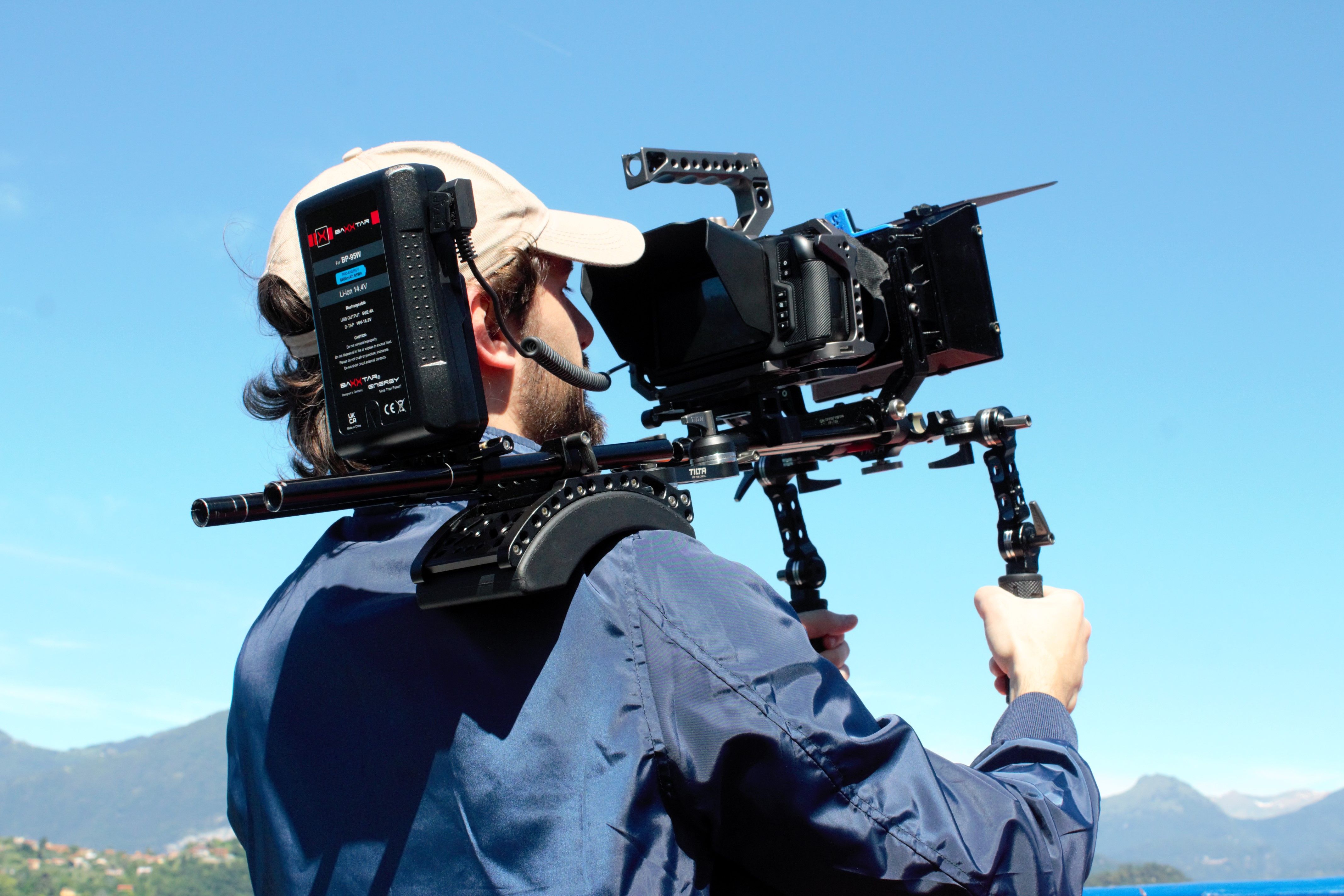 A Cameraman Holding a Professional Camera and Filming Outside · Free ...