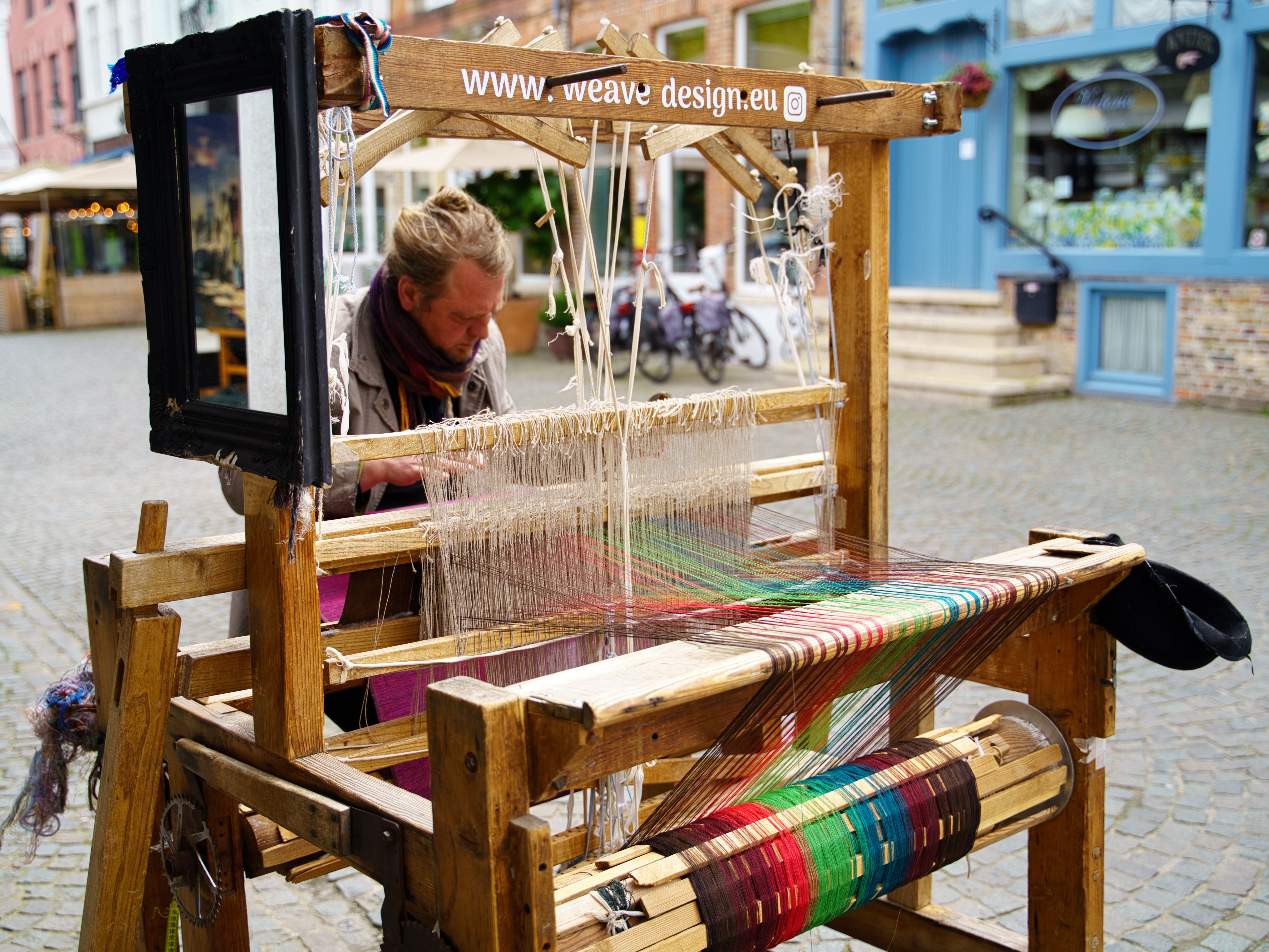 Man Weaving on Vintage Loom on Street · Free Stock Photo