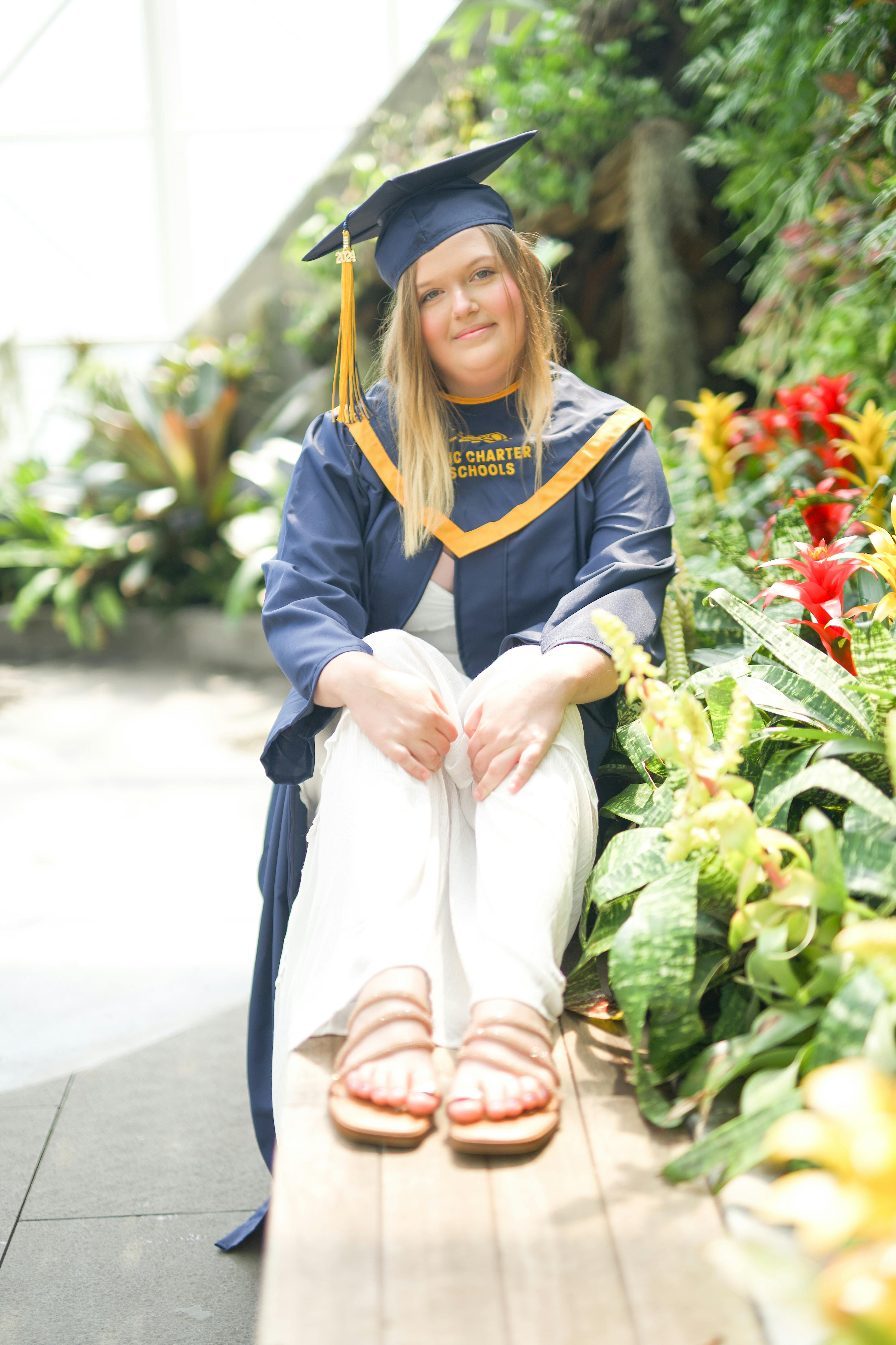 Blonde Woman in Gown and Hat Sitting on Bench After Graduation · Free ...