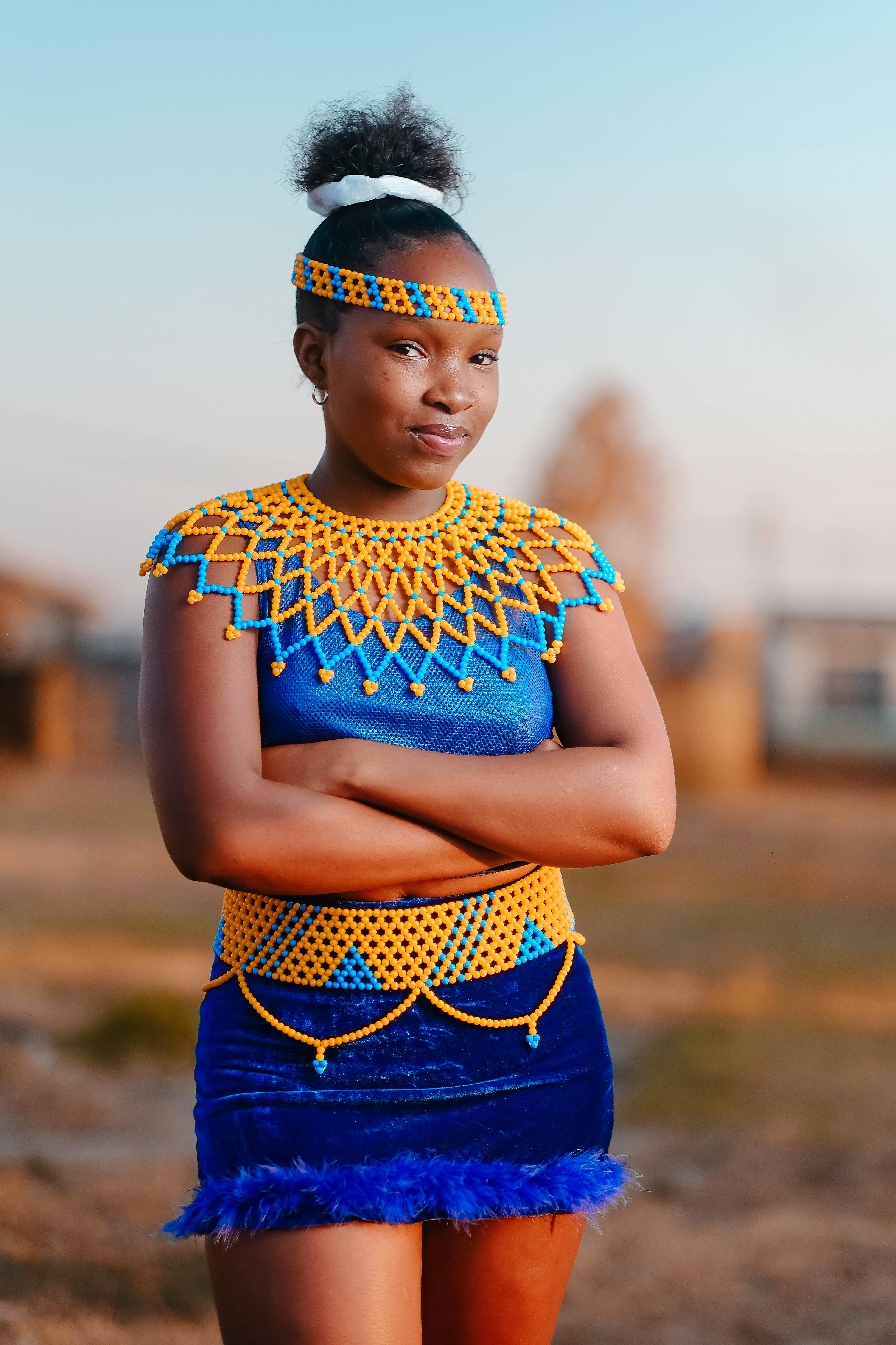 Young Woman in Blue and Yellow Traditional Clothing Standing Outside ...