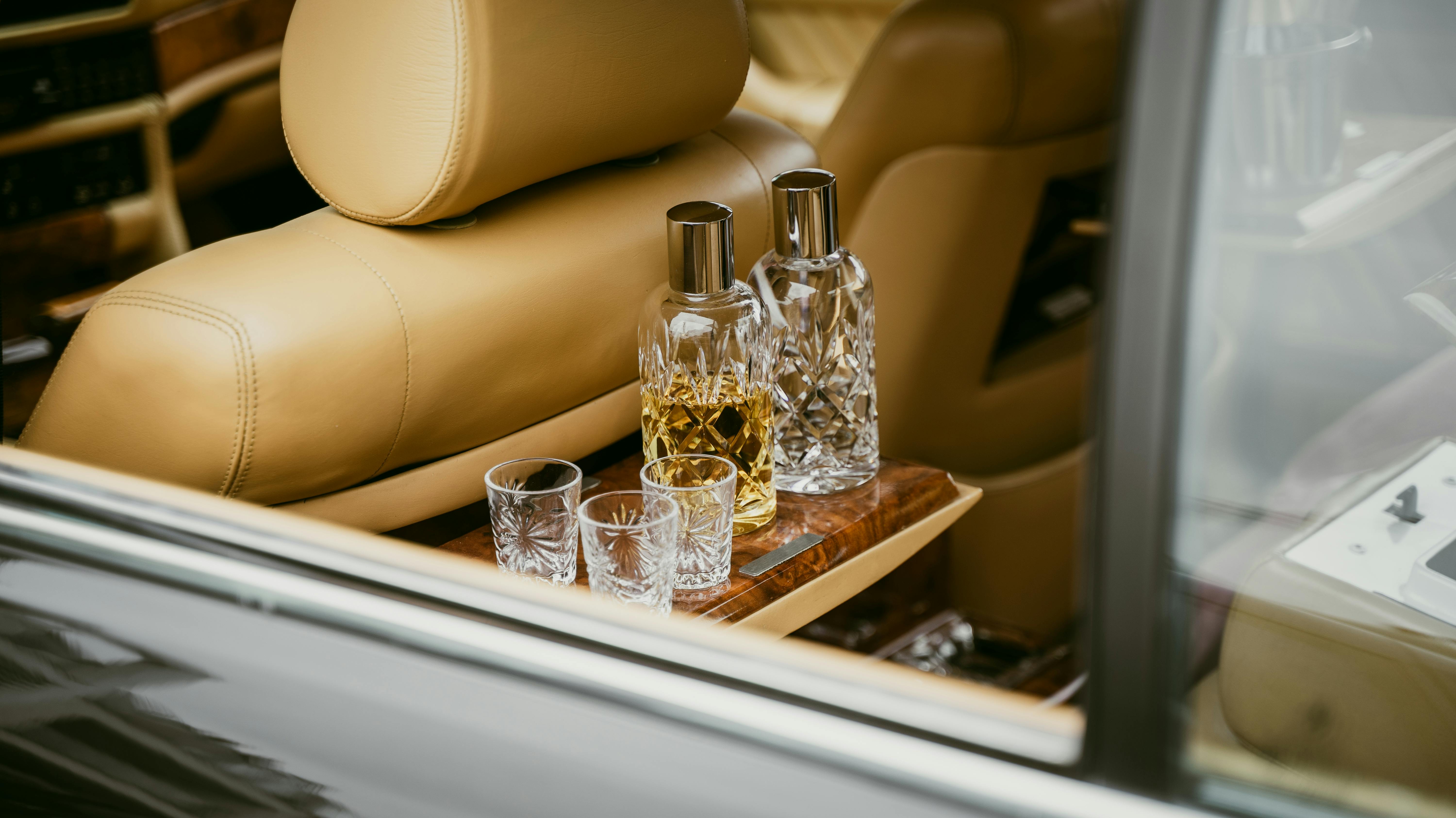 Bottles with Vodka and Whiskey in Car · Free Stock Photo