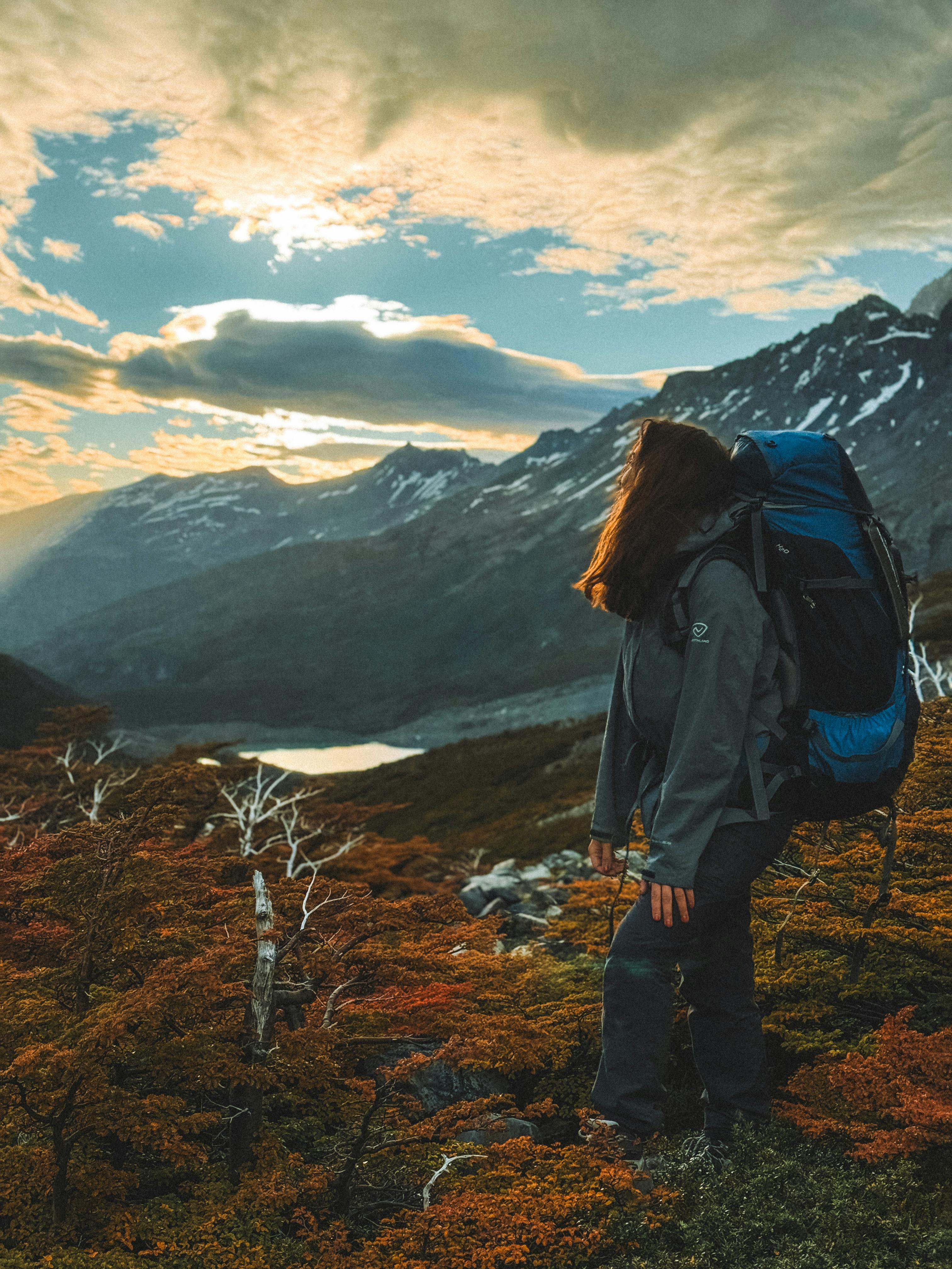Woman with Backpack in Mountains at Sunset · Free Stock Photo