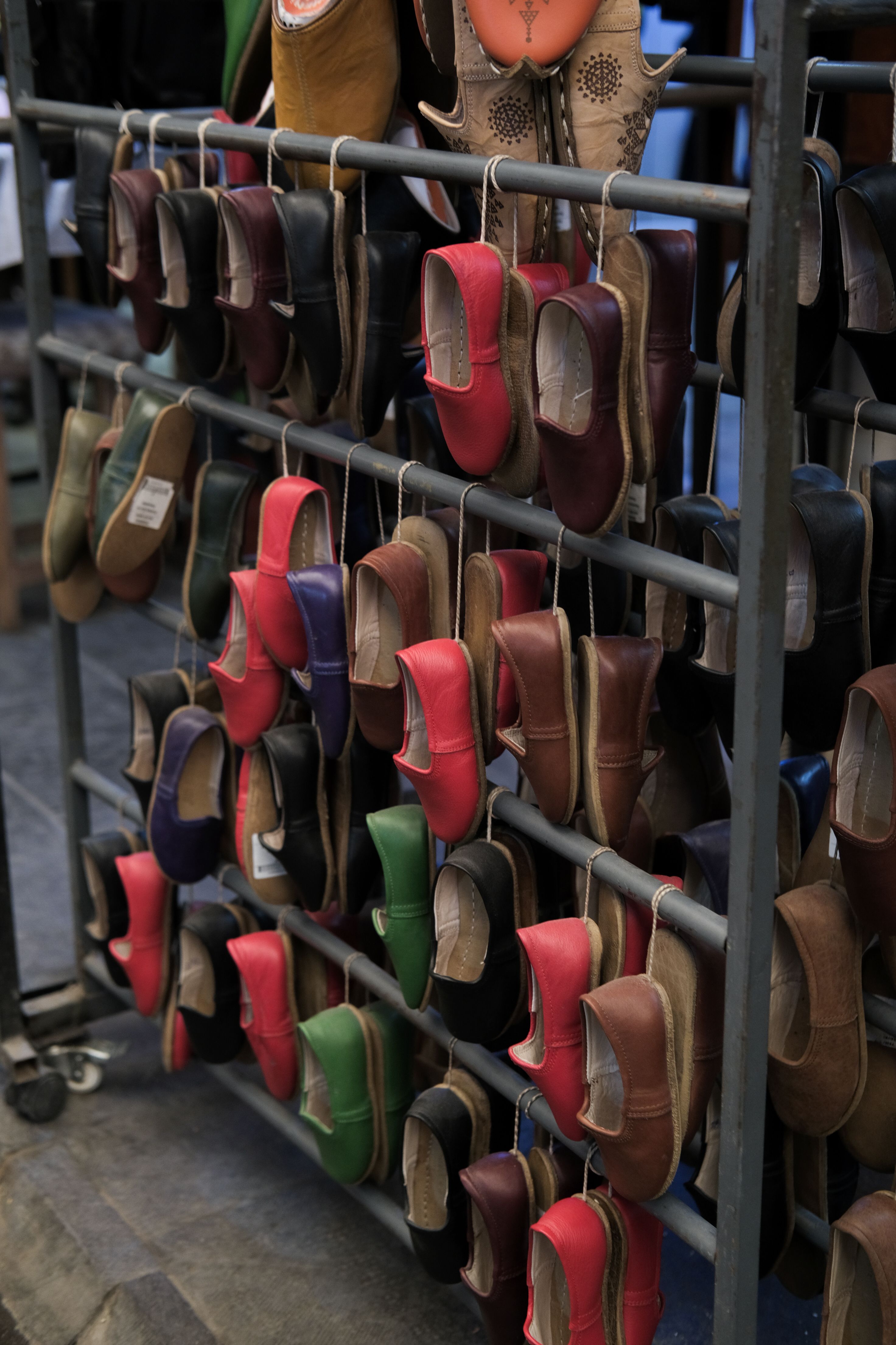 Various Leather Shoes Hanging on a Stall Rack · Free Stock Photo