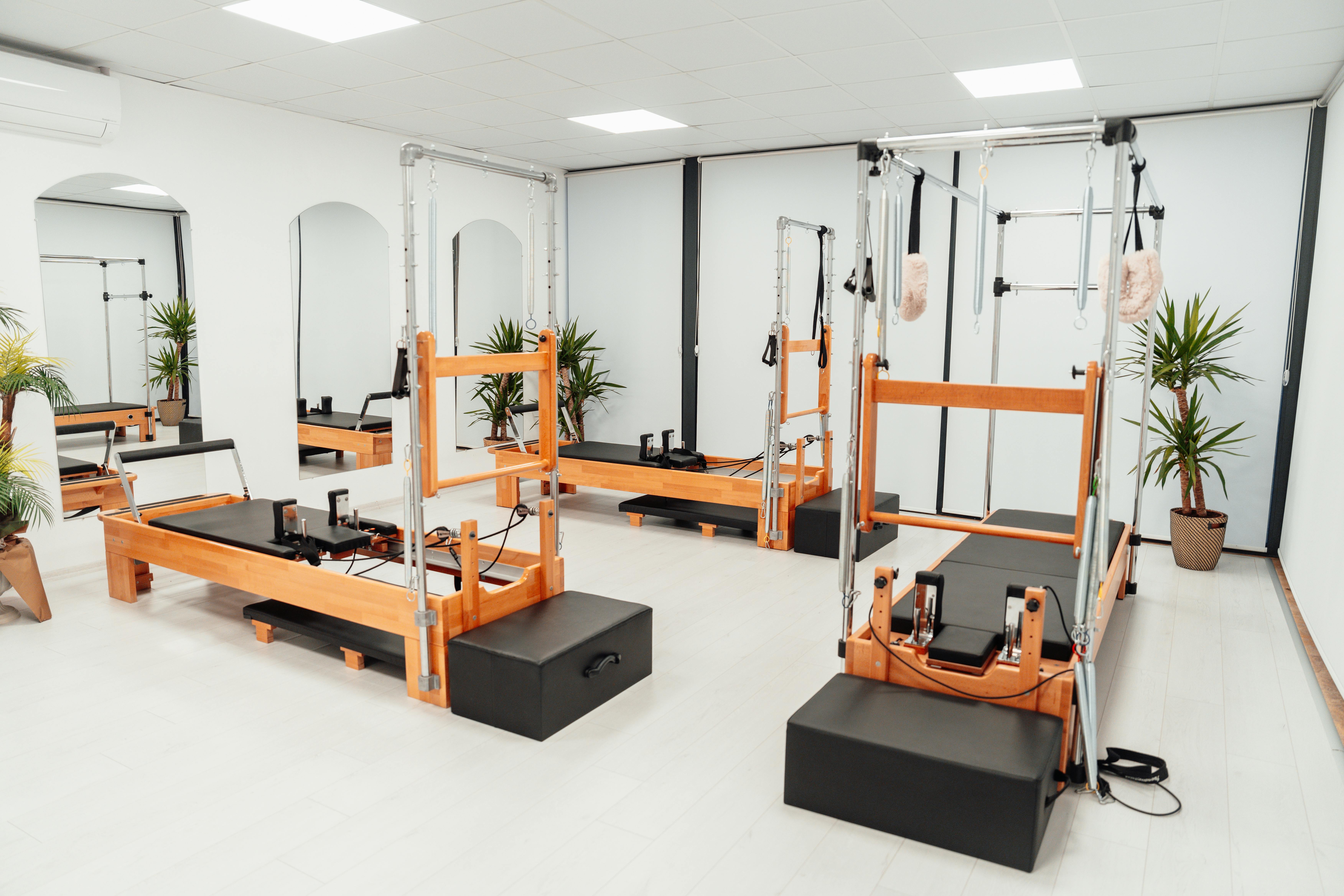 Pilates studio with orange and black equipment · Free Stock Photo