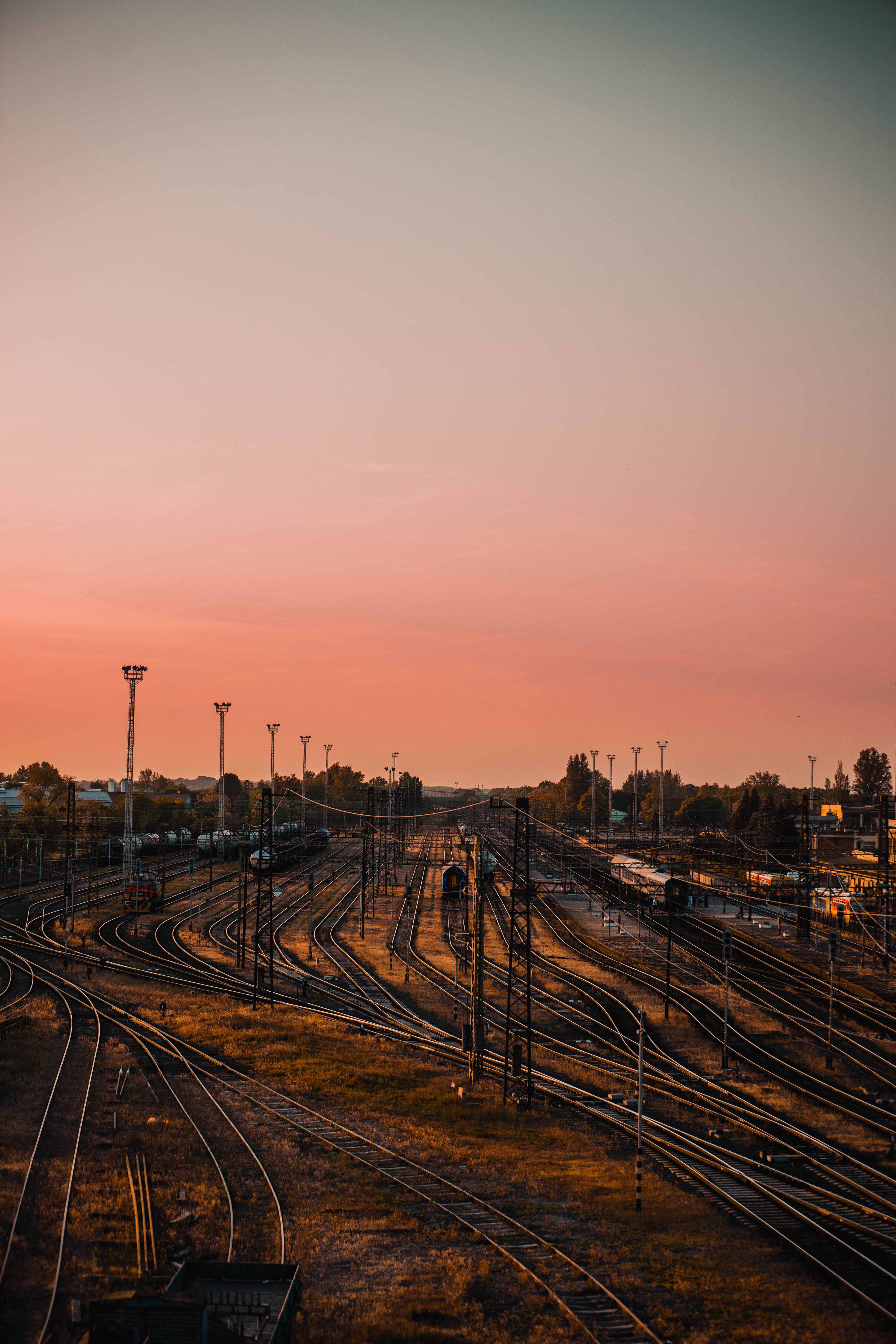 A sunset over railroad tracks with a train in the distance · Free Stock ...