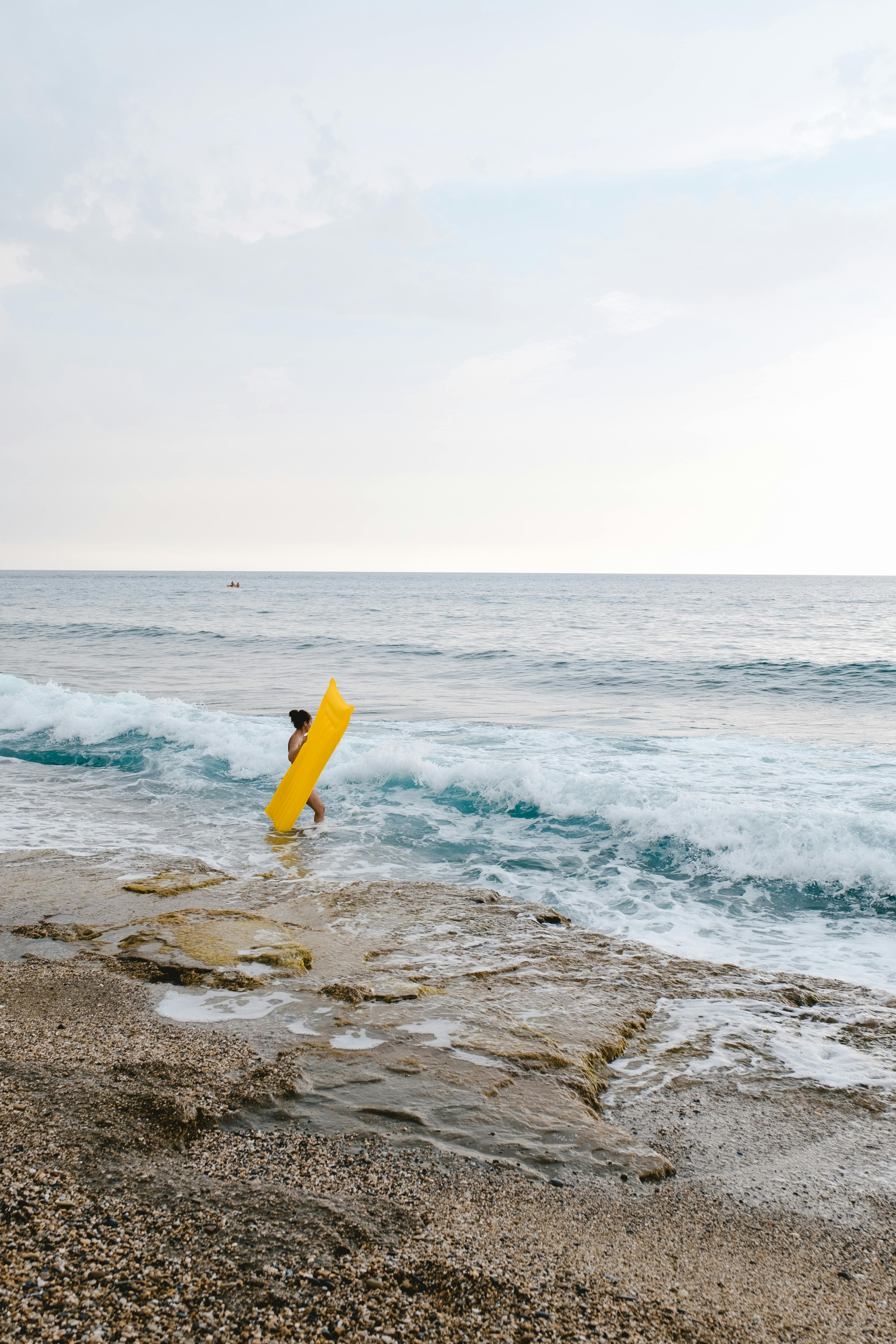 Person Standing Near Body of Water · Free Stock Photo