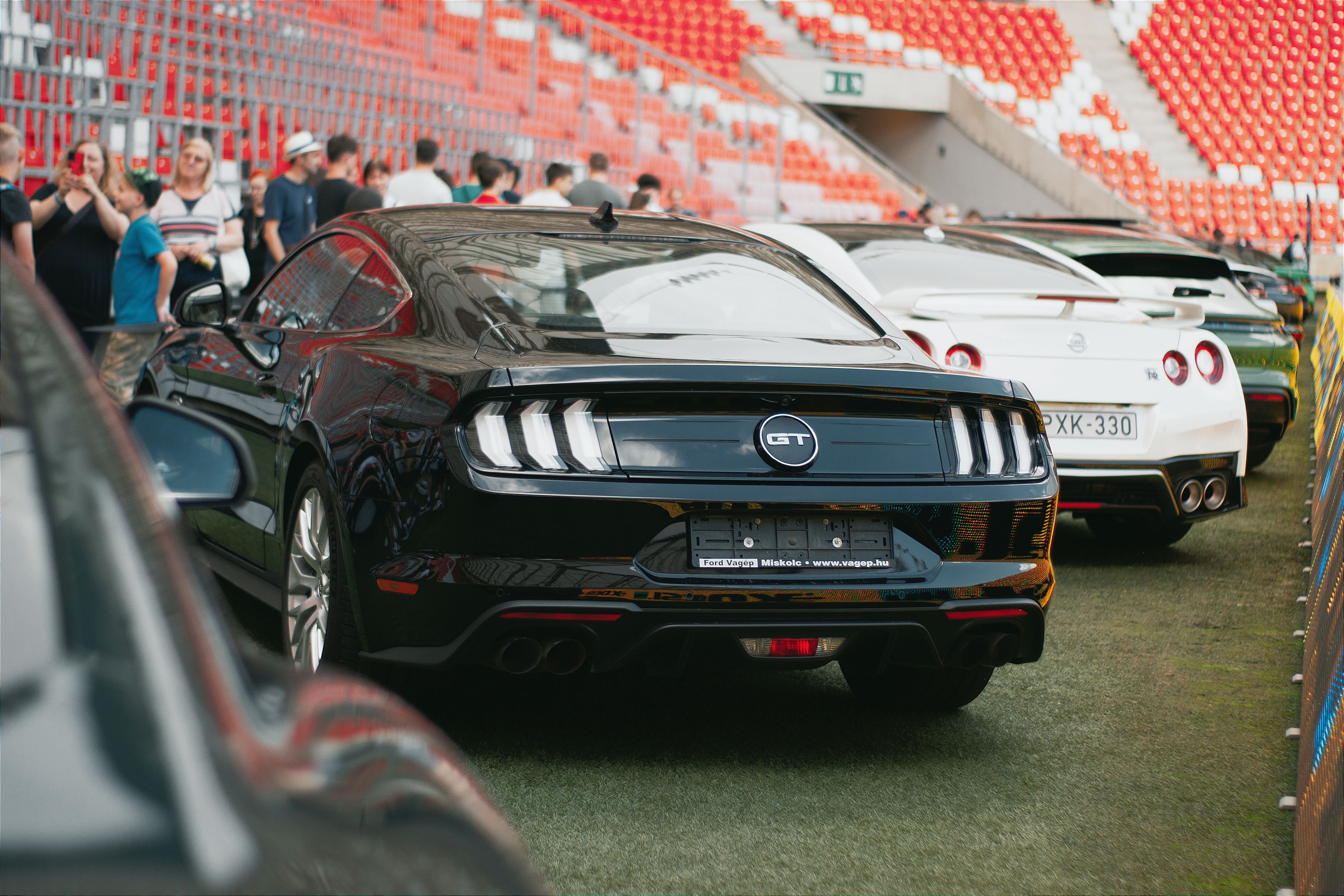 A group of cars parked in a stadium · Free Stock Photo