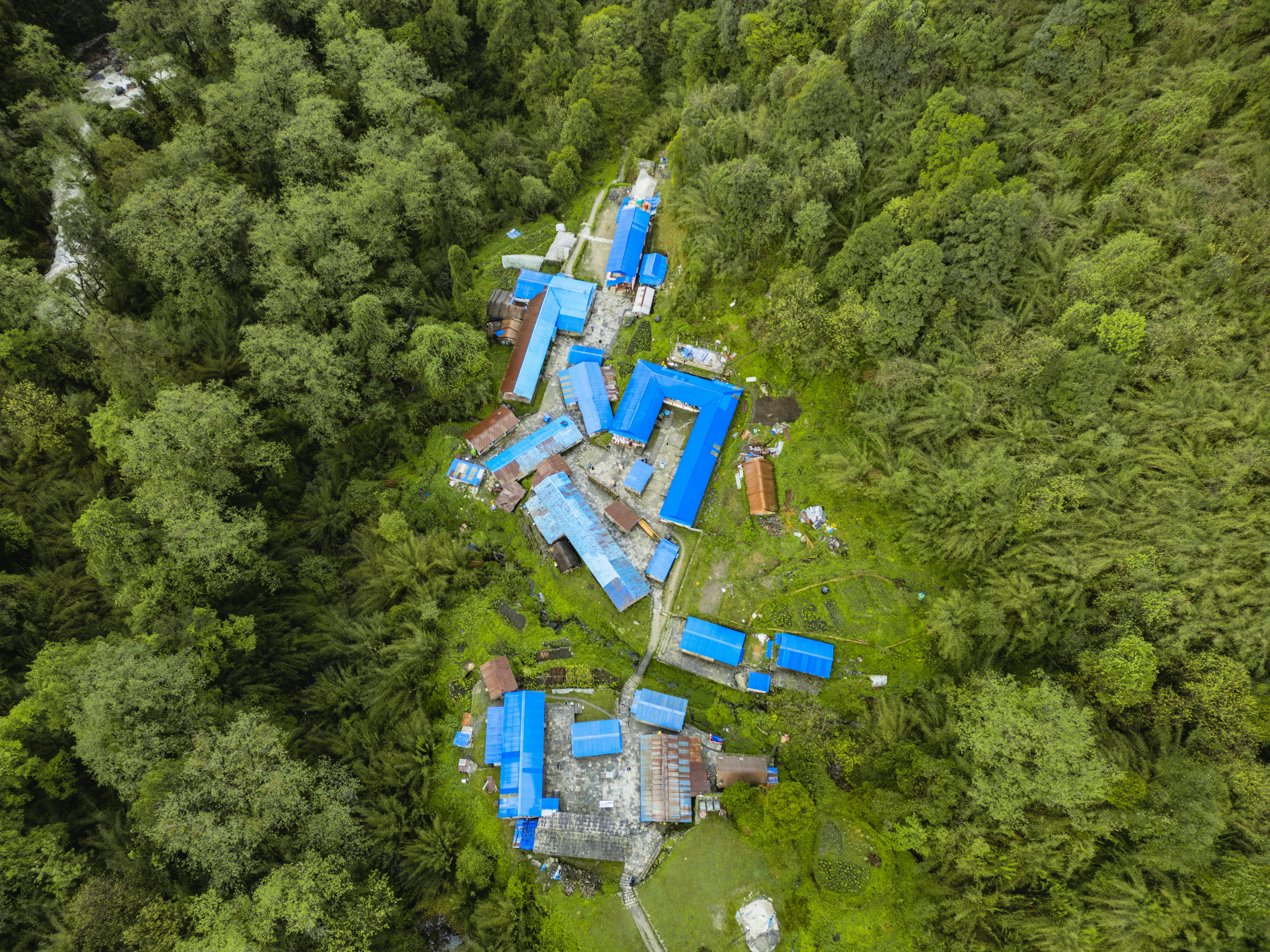 An aerial view of a small village in the forest · Free Stock Photo