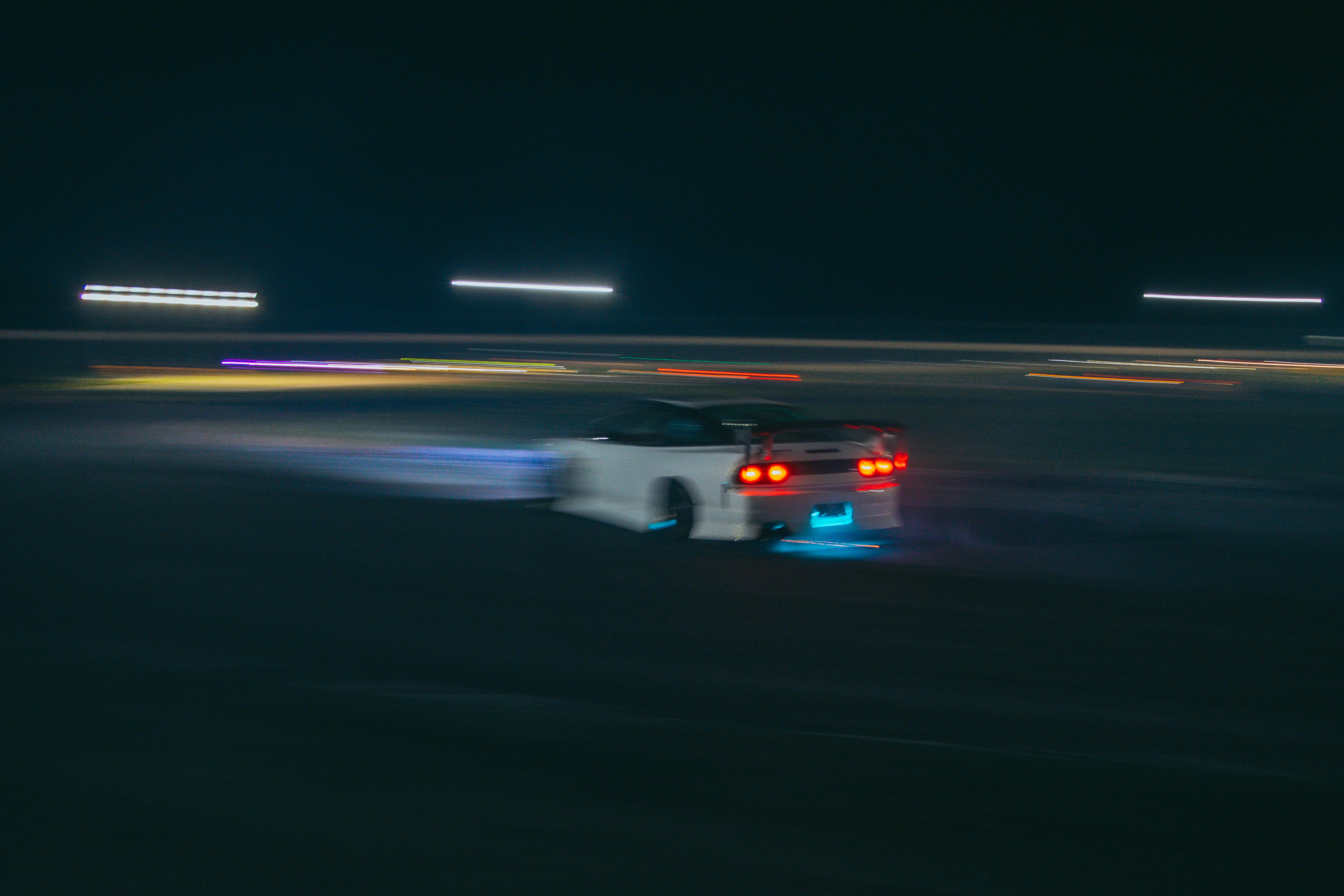 Nissan Car Racing at Circuit at Night · Free Stock Photo