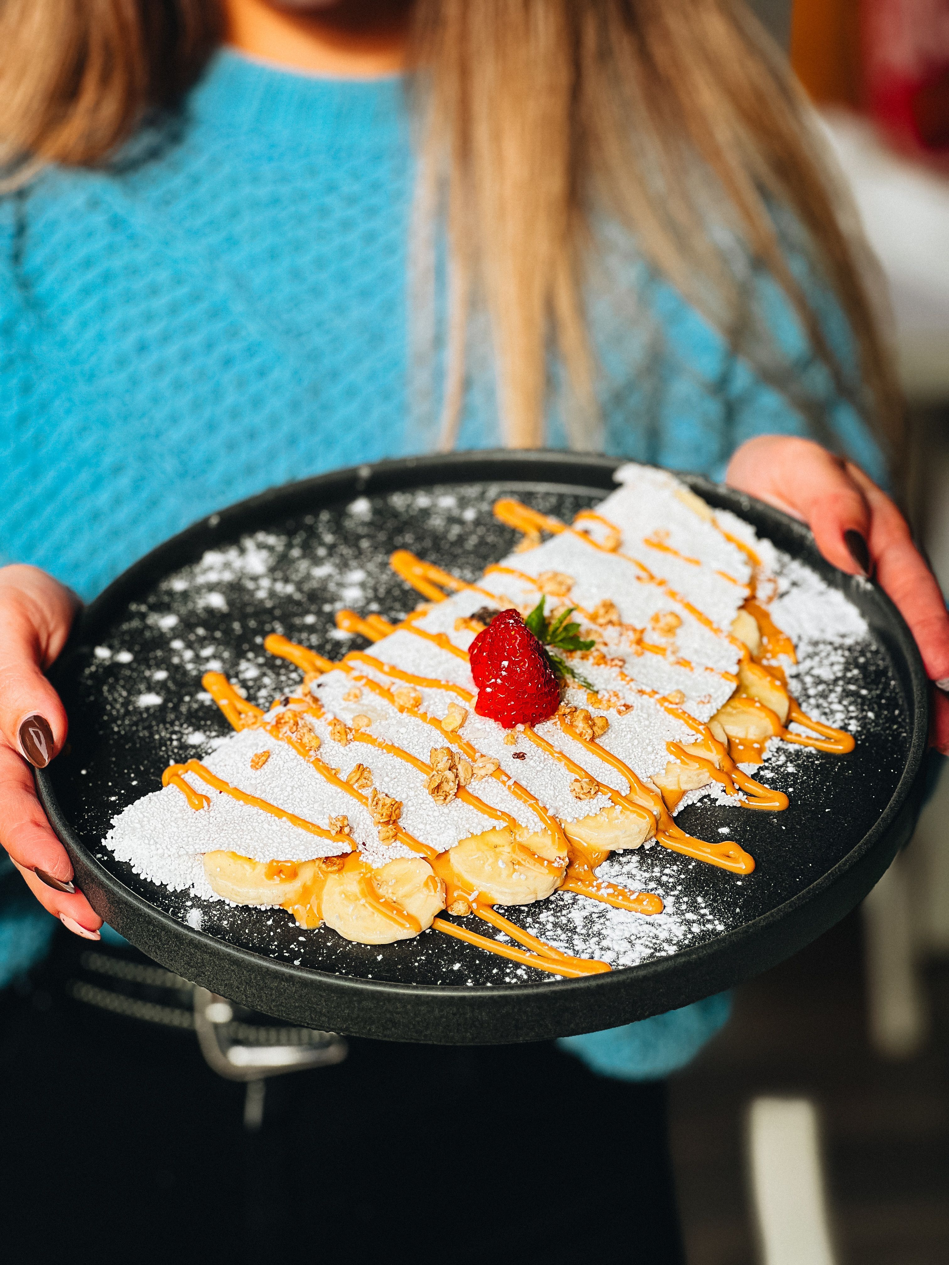 A Woman Holding a Plate with a Dessert · Free Stock Photo