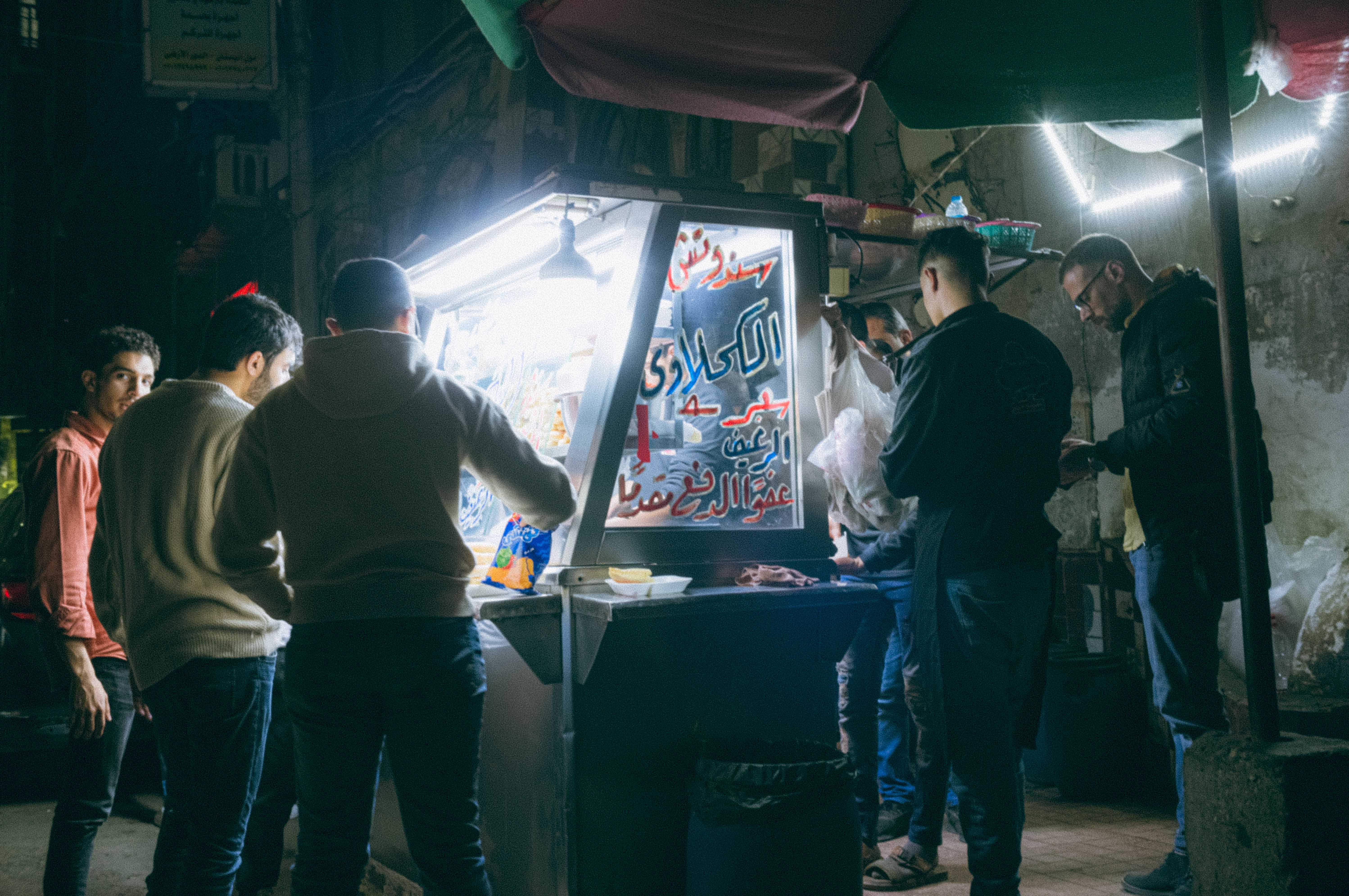 Men by Street Food Stall at Night · Free Stock Photo