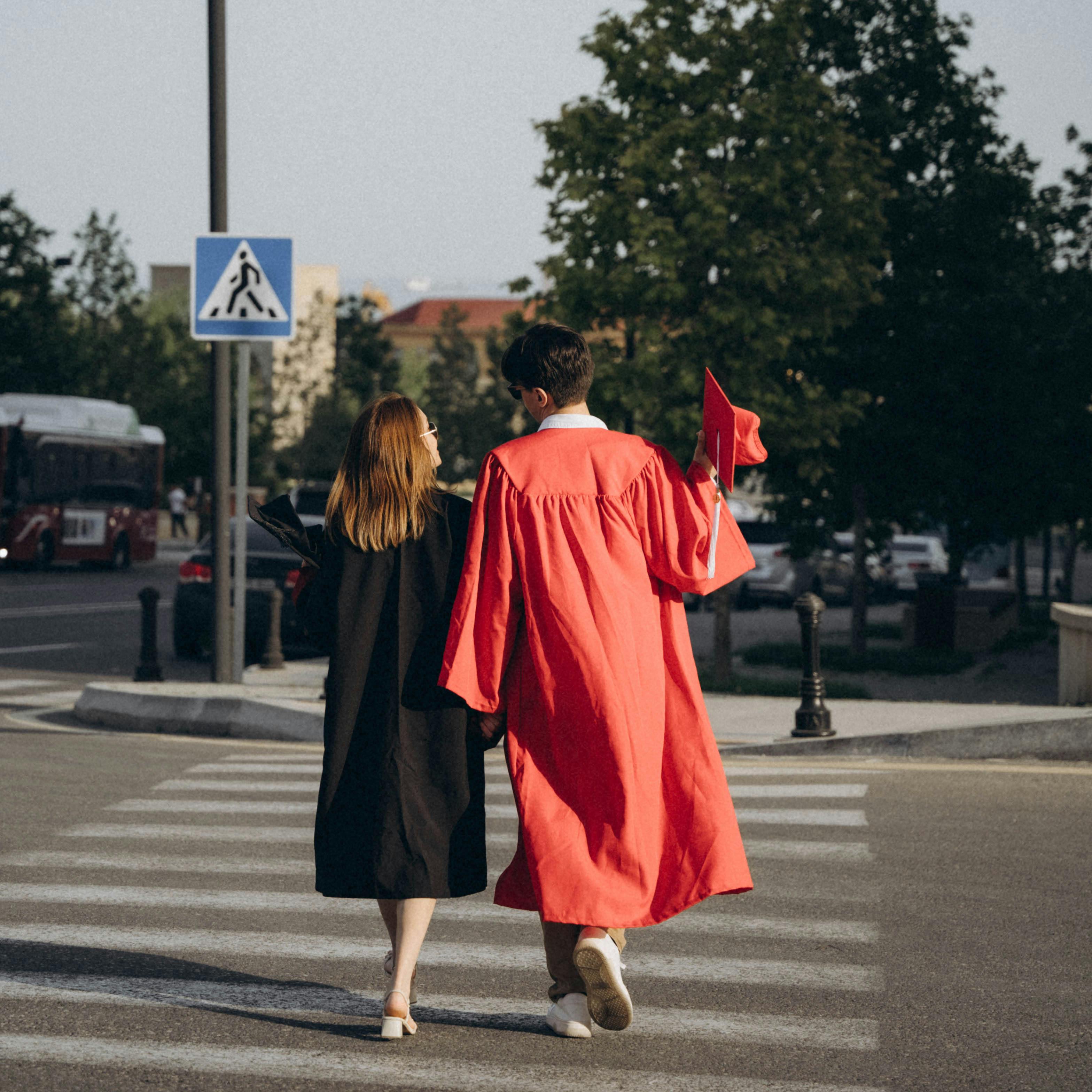 Back View of Couple of Graduates Crossing Street · Free Stock Photo