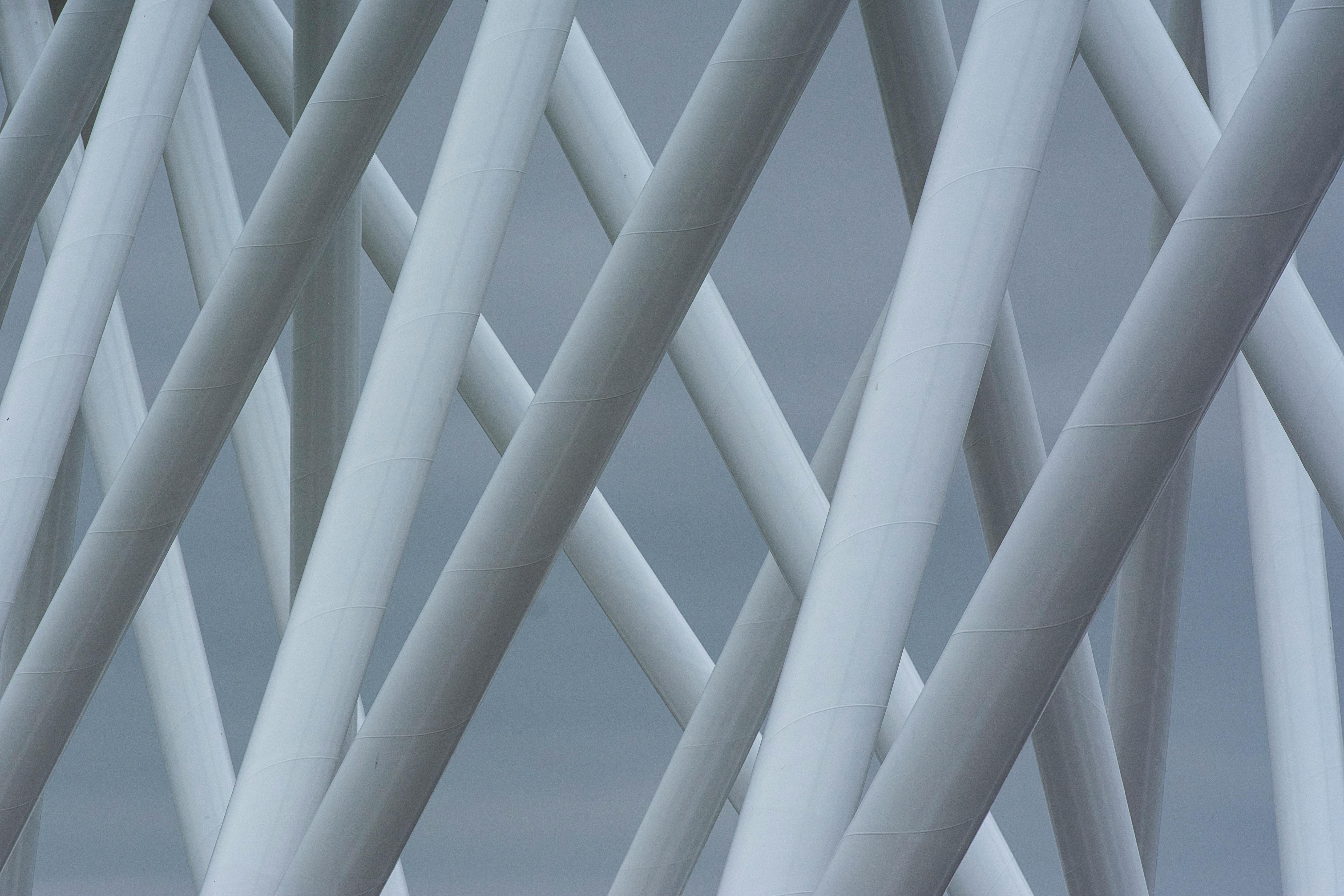Steel Poles Interlocked Against a Grey Sky · Free Stock Photo