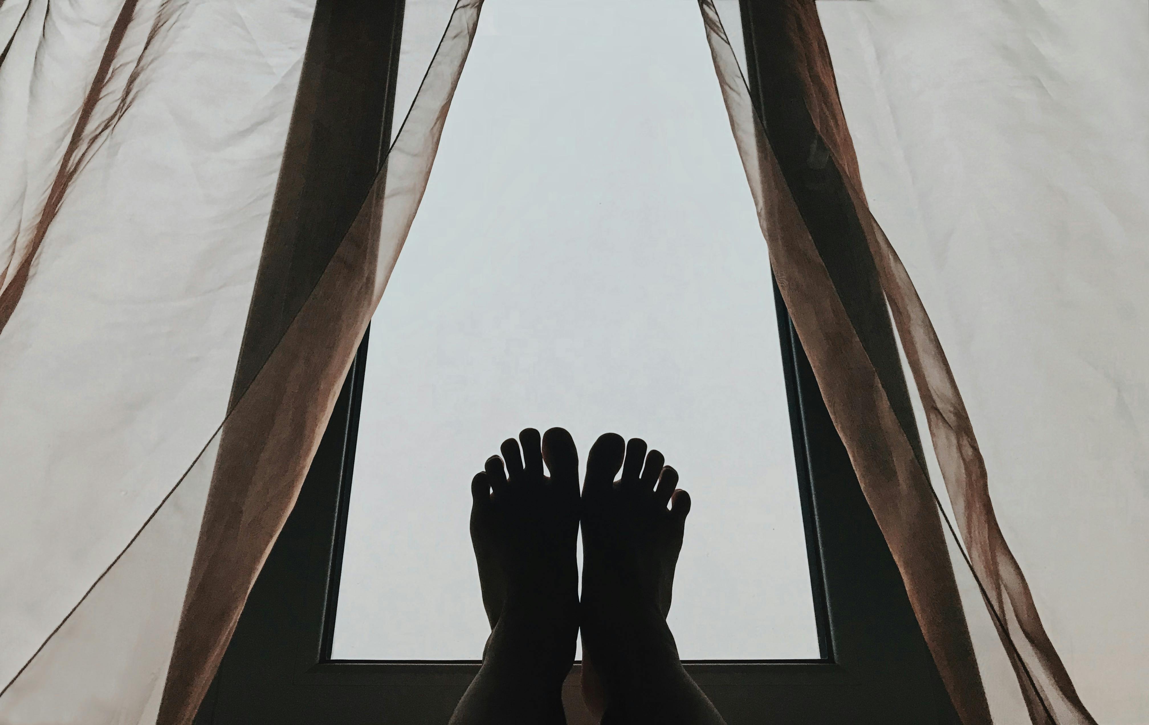 Silhoutte of Person's Feet on Glass · Free Stock Photo