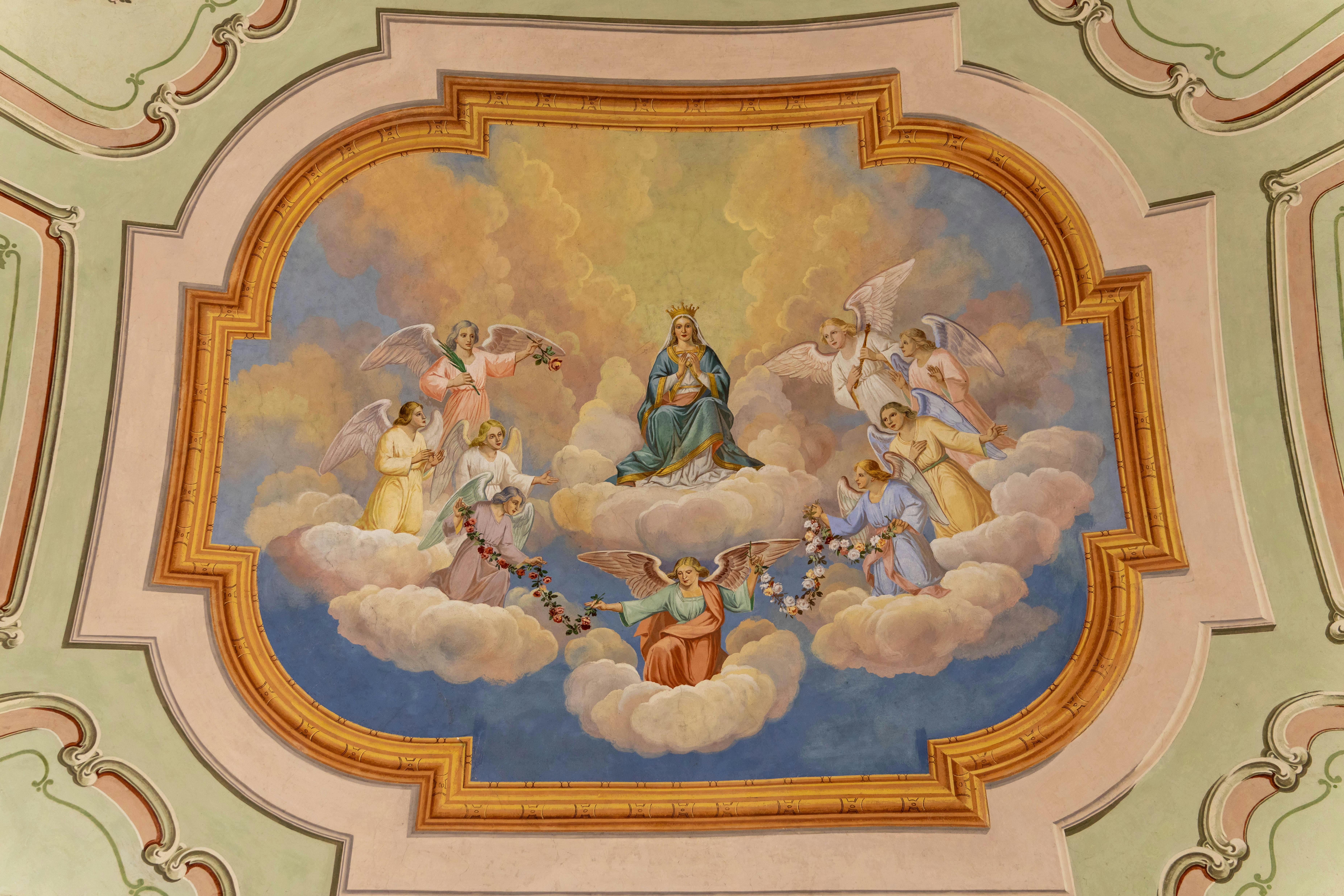 A painting on the ceiling of a church with angels · Free Stock Photo