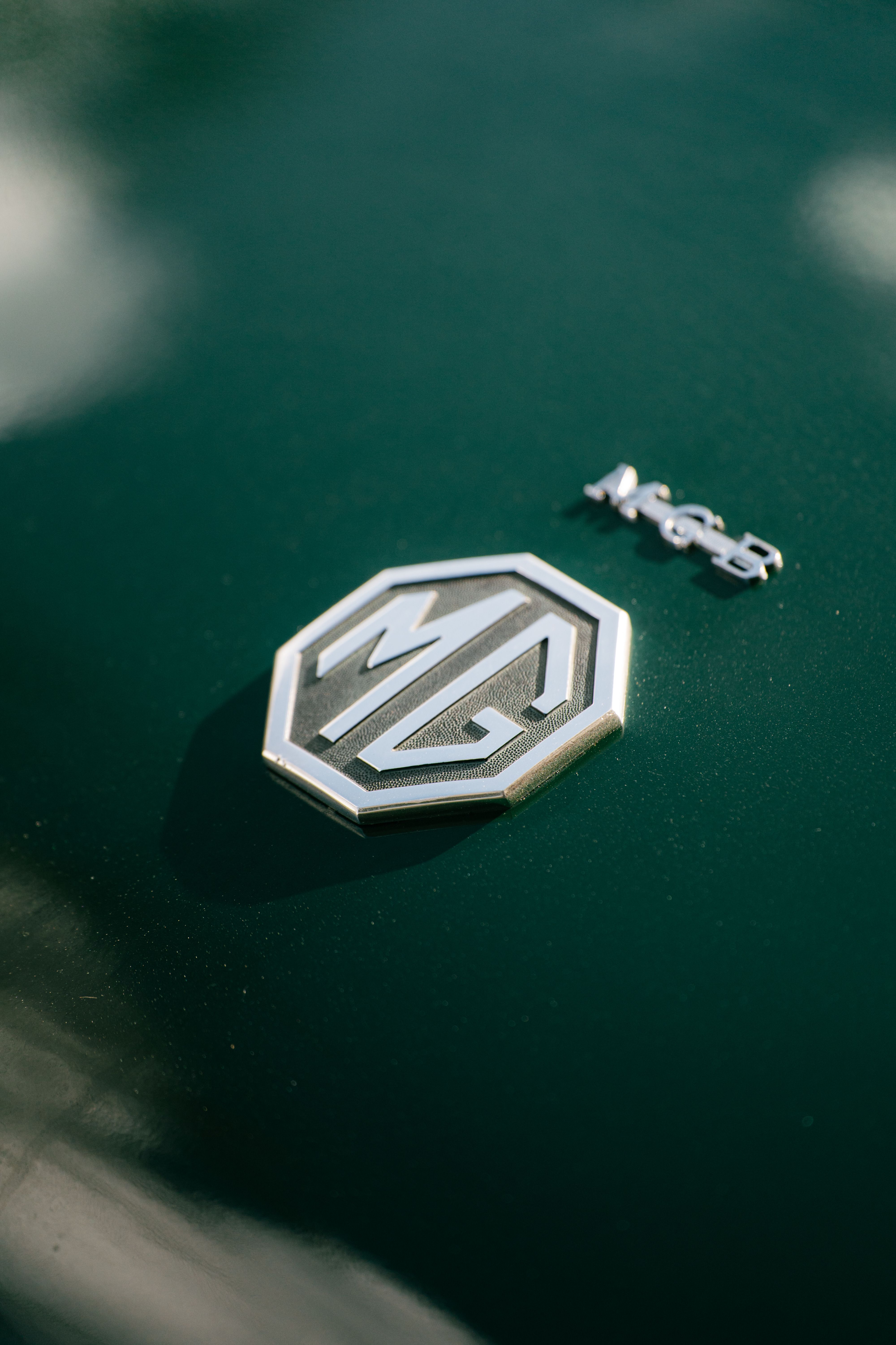 Hood Logo on a Green MG MGB Car · Free Stock Photo