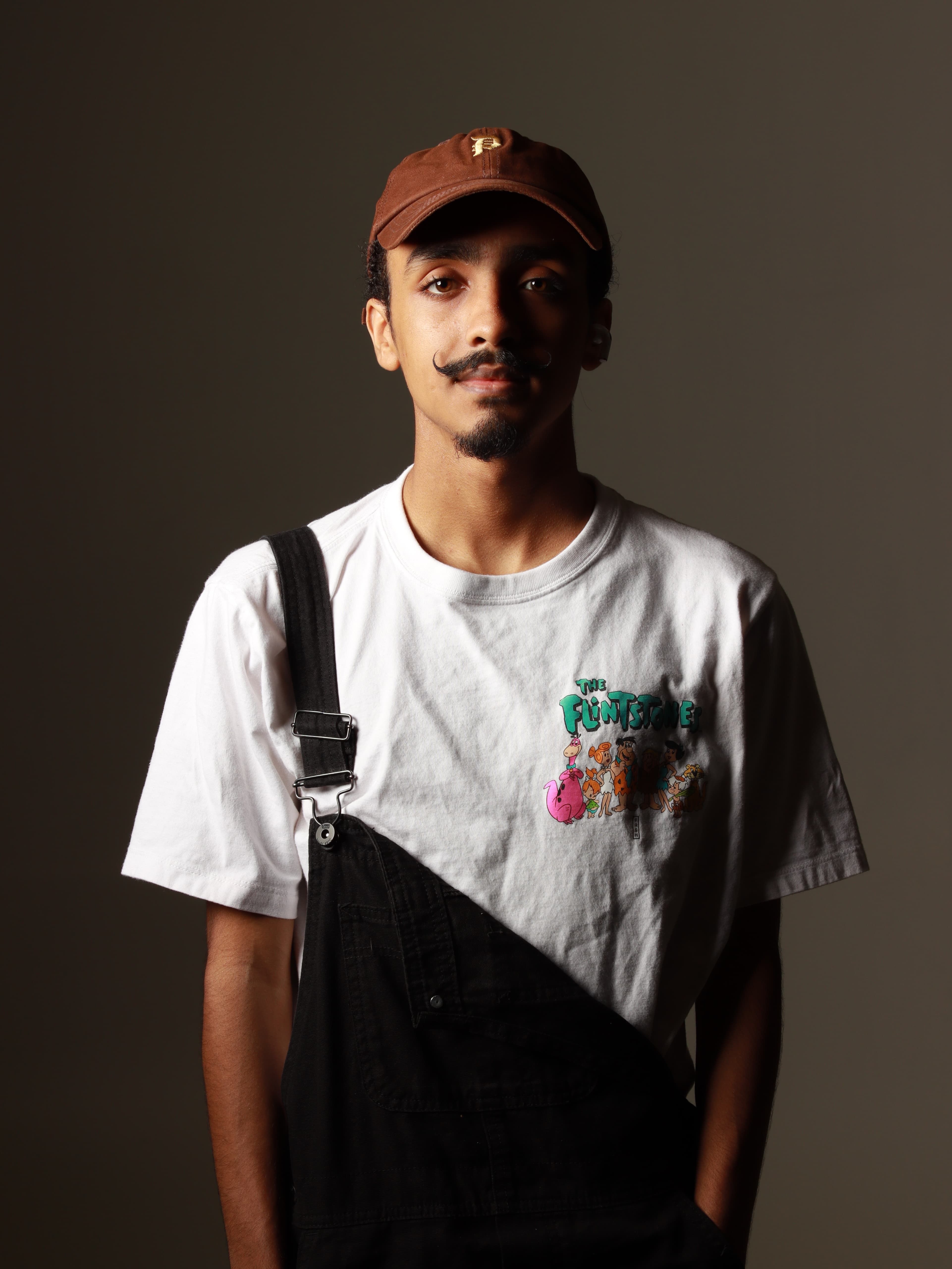 Man Wearing Overalls and a Cap · Free Stock Photo