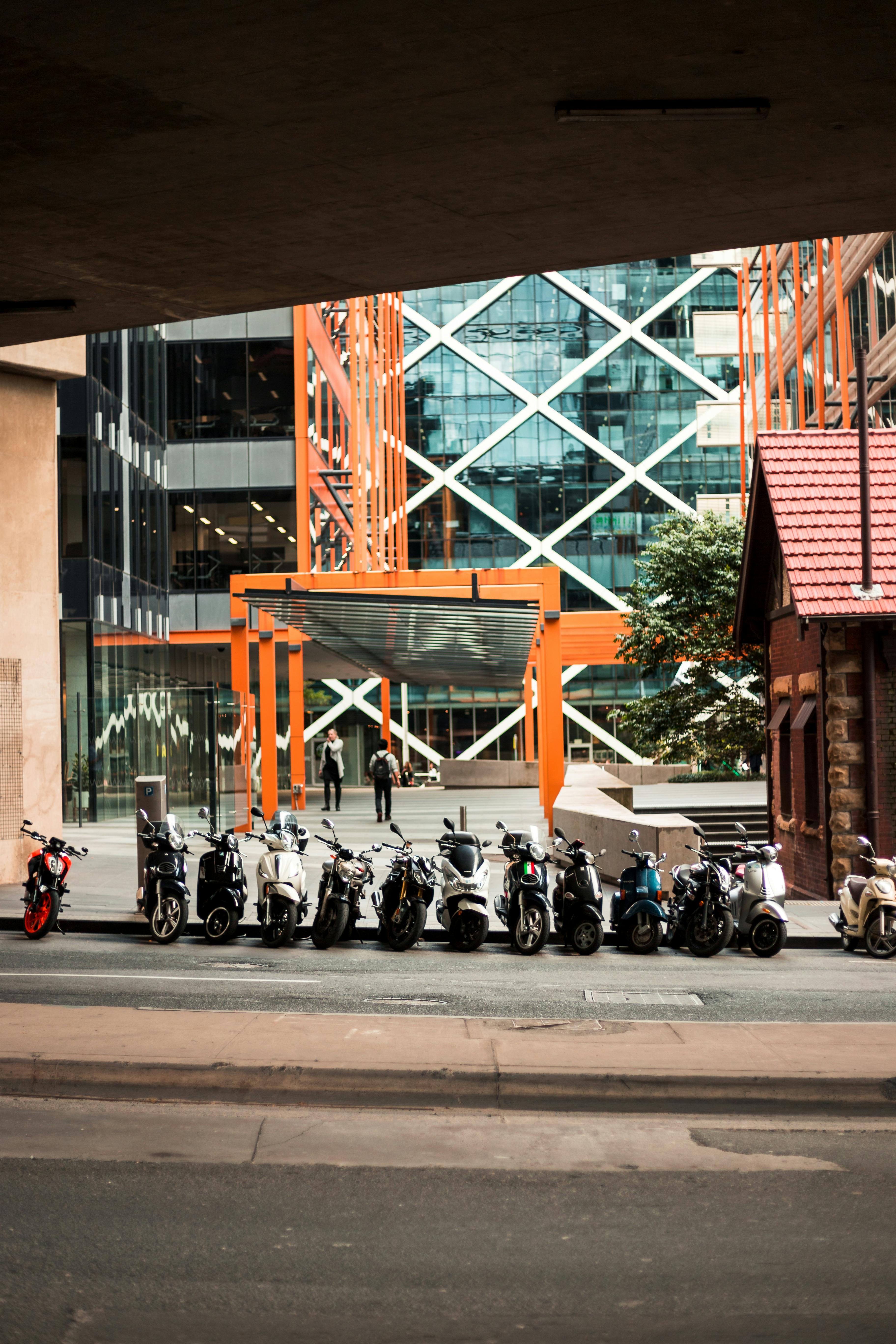 Motorcycles Parked Beside Building · Free Stock Photo