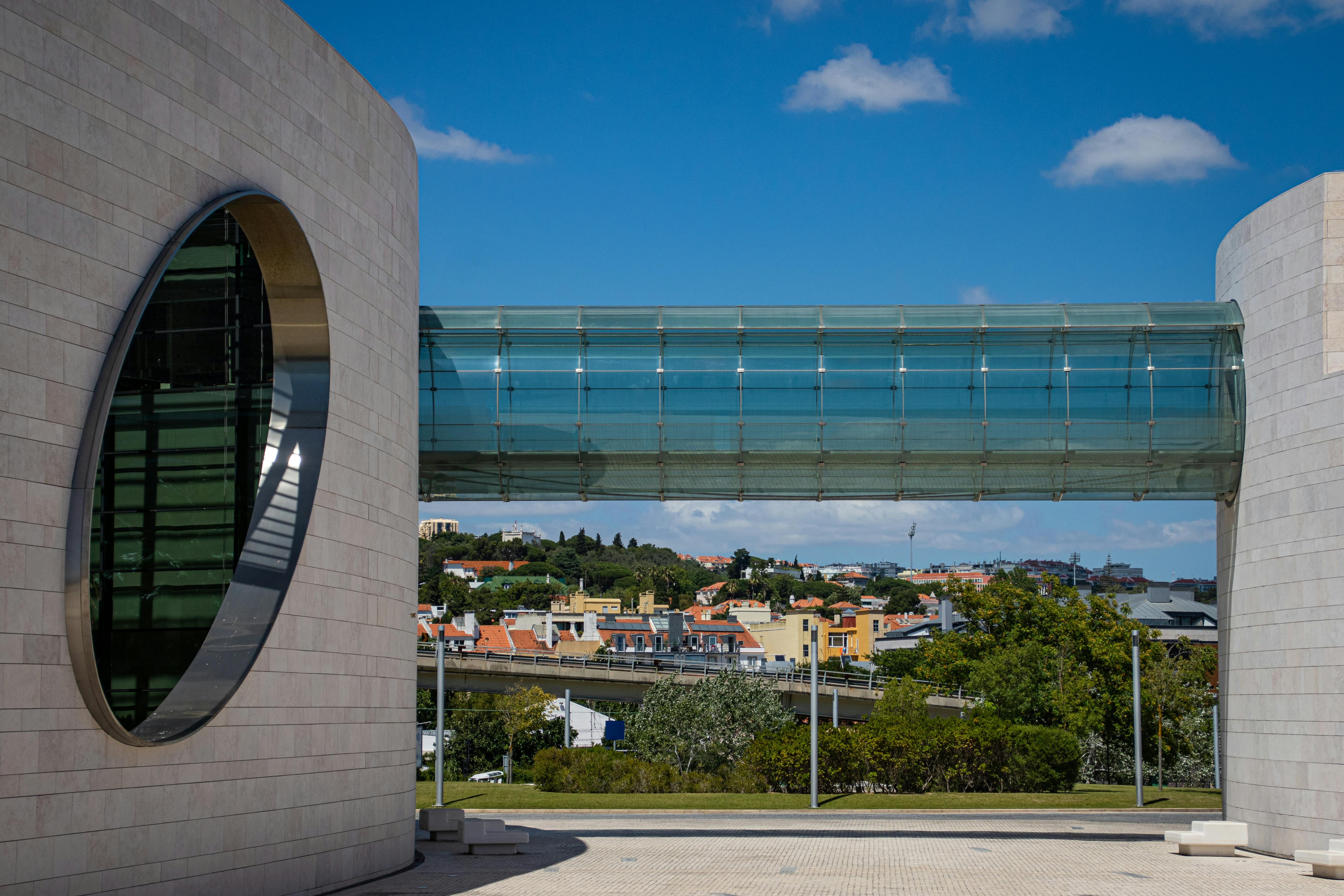 Glass Bridge Connecting Two Concrete Buildings · Free Stock Photo
