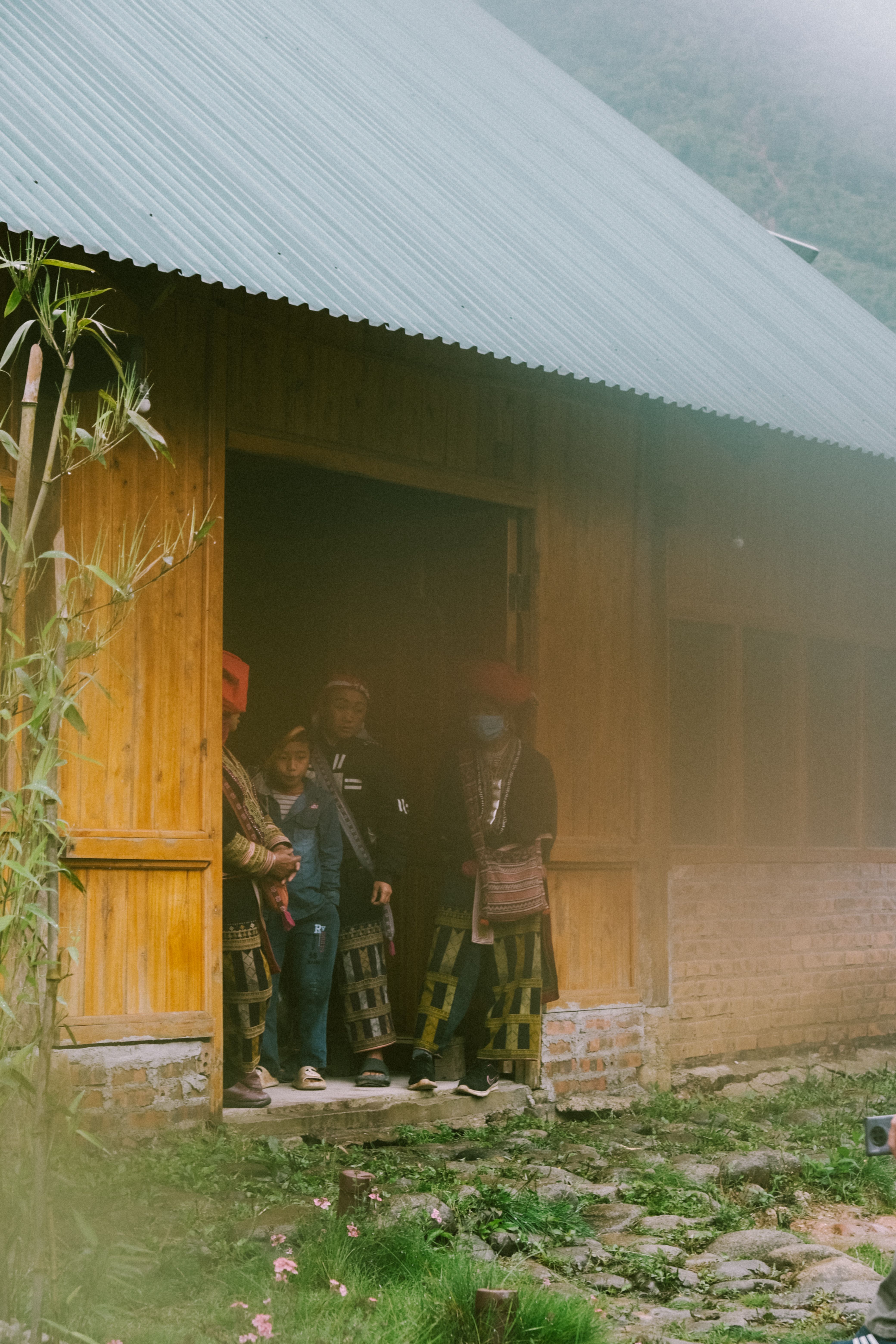 People Standing in Village House Entrance · Free Stock Photo