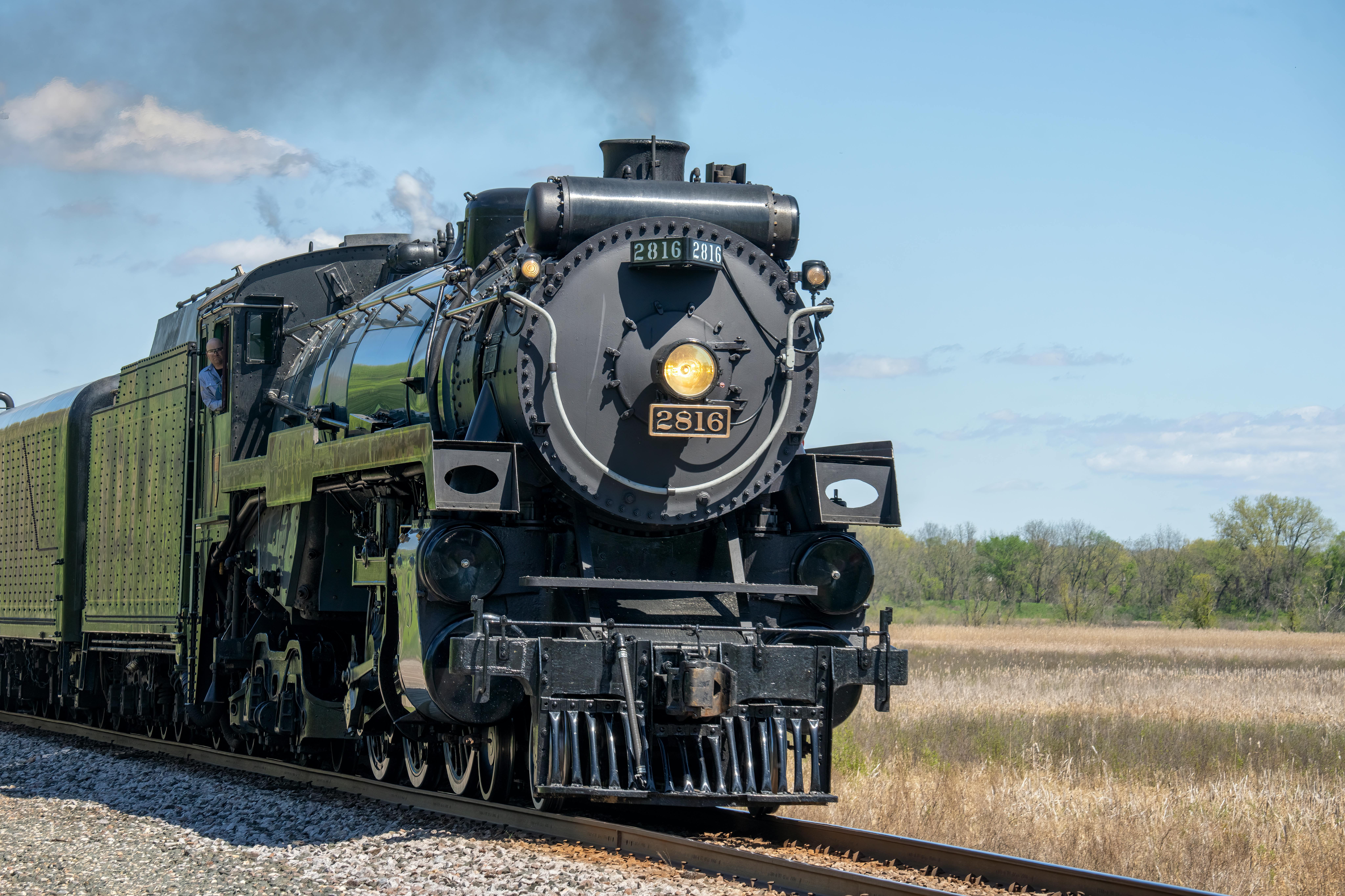 Engineer Looking Out of the Window of a Steam Locomotive · Free Stock Photo
