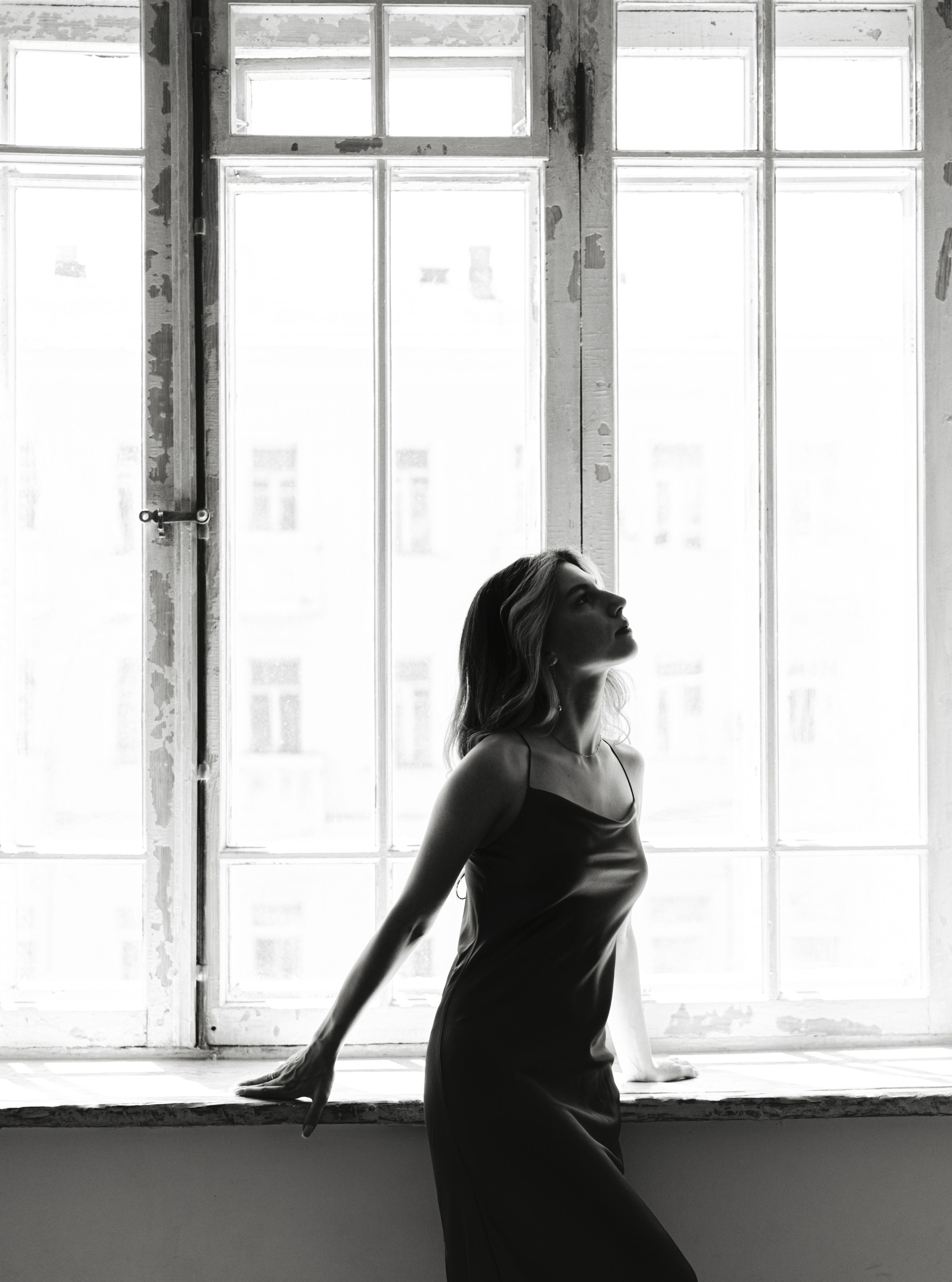 Portrait of a Female Model Leaning on a Window Sill · Free Stock Photo