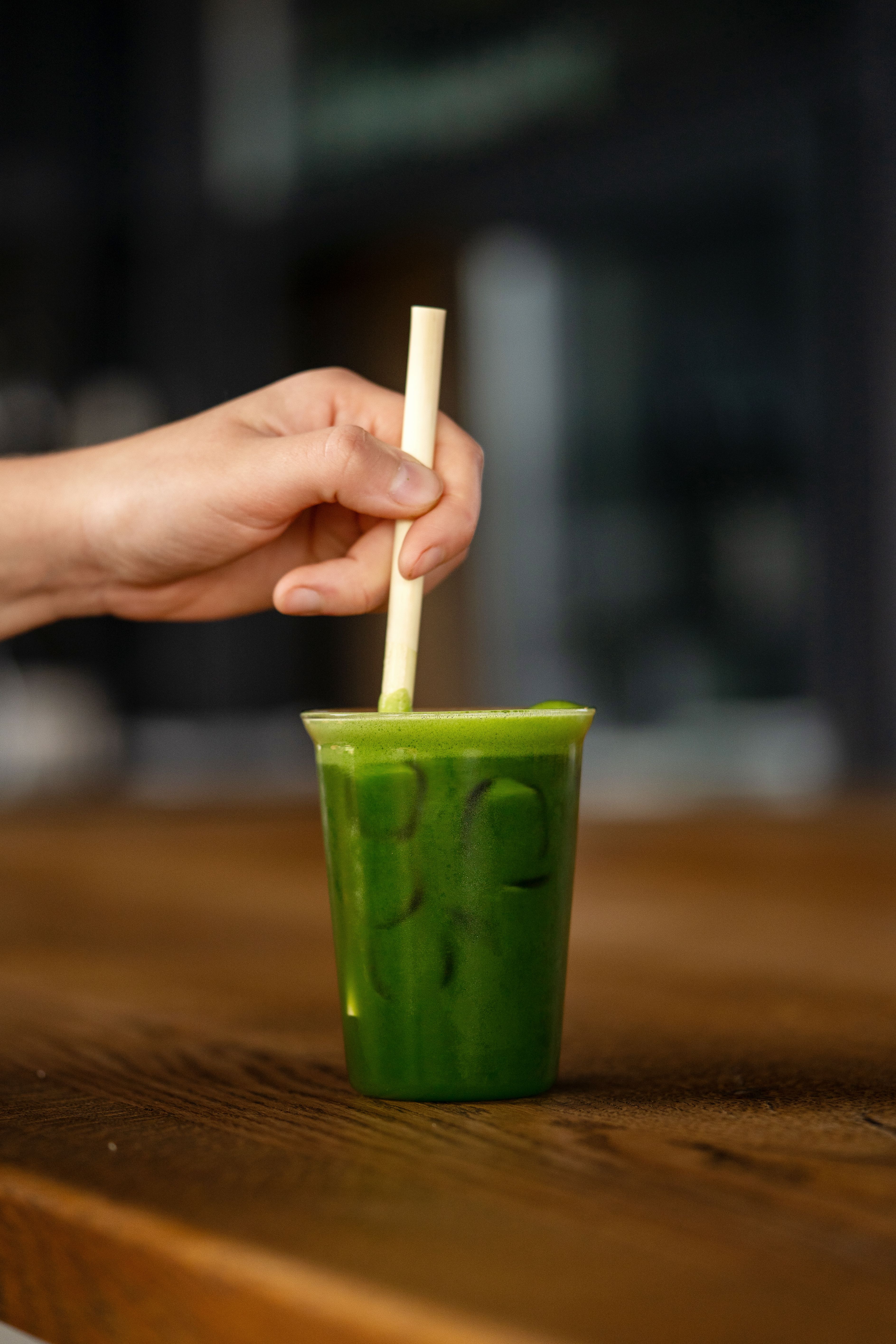 Hand Holding Straw in Glass of Cocktail · Free Stock Photo