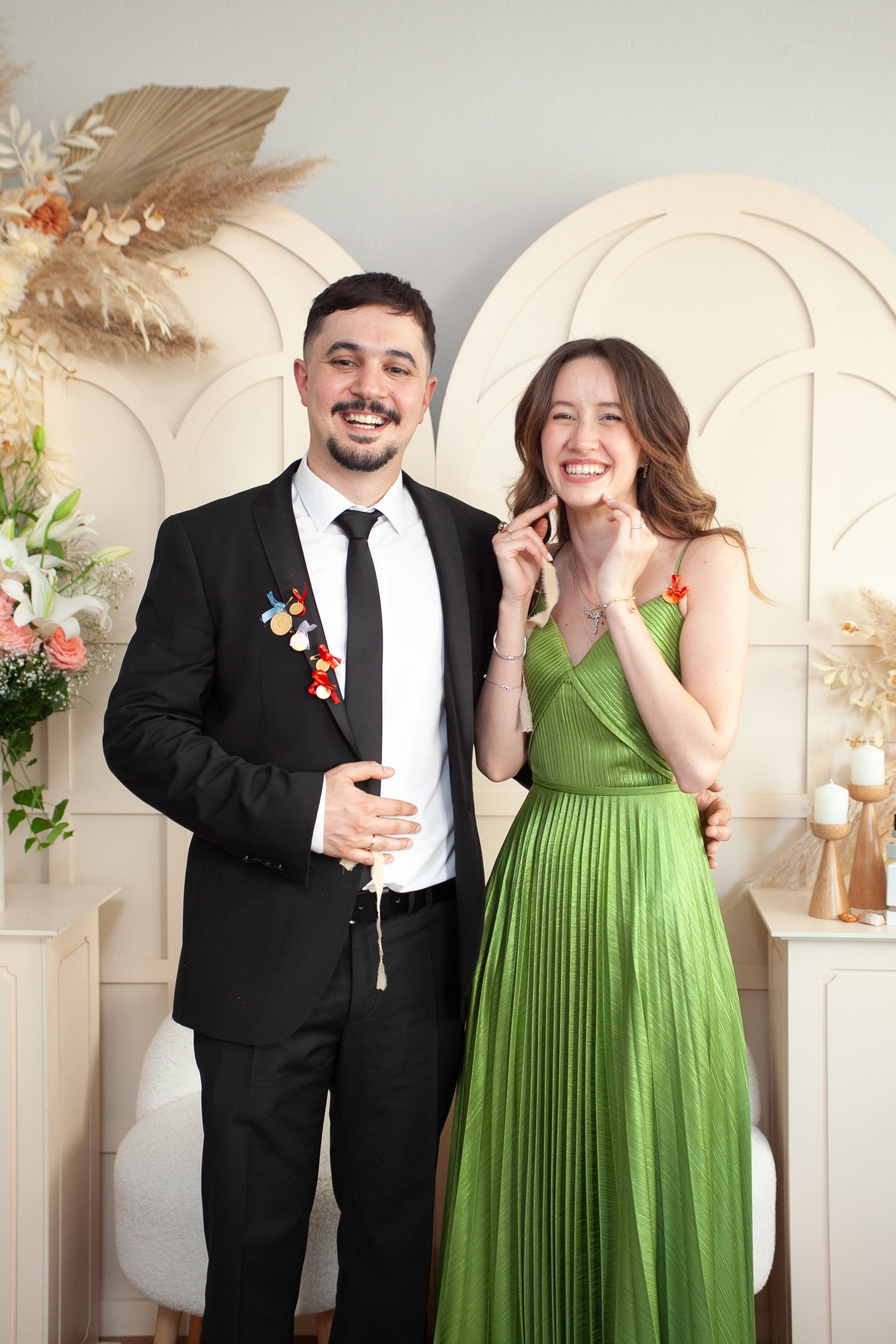 Guest Couple Posing in Front of Wedding Arch · Free Stock Photo