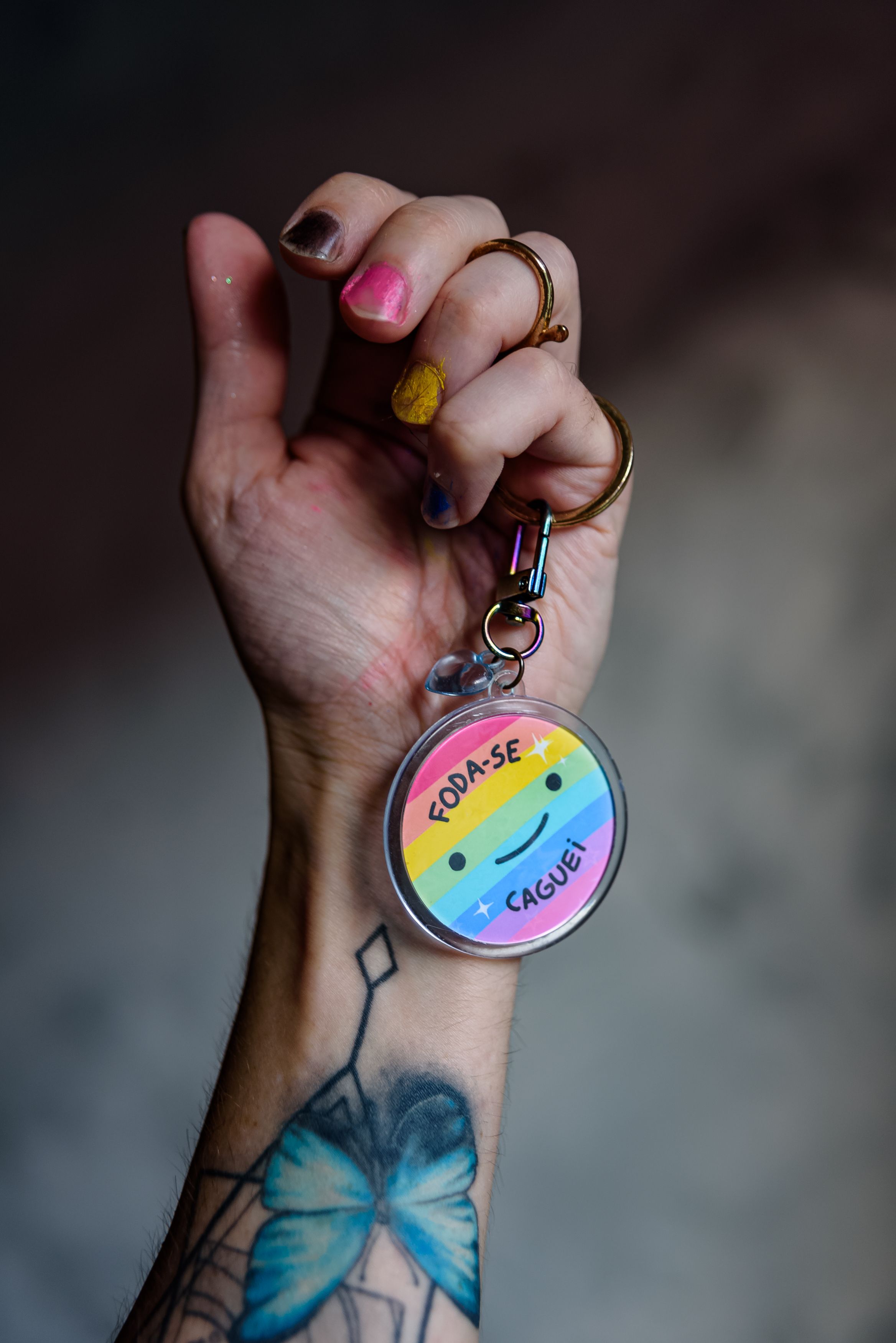 Close-up of a Person with Tattoos Holding a Colorful Key Chain · Free ...