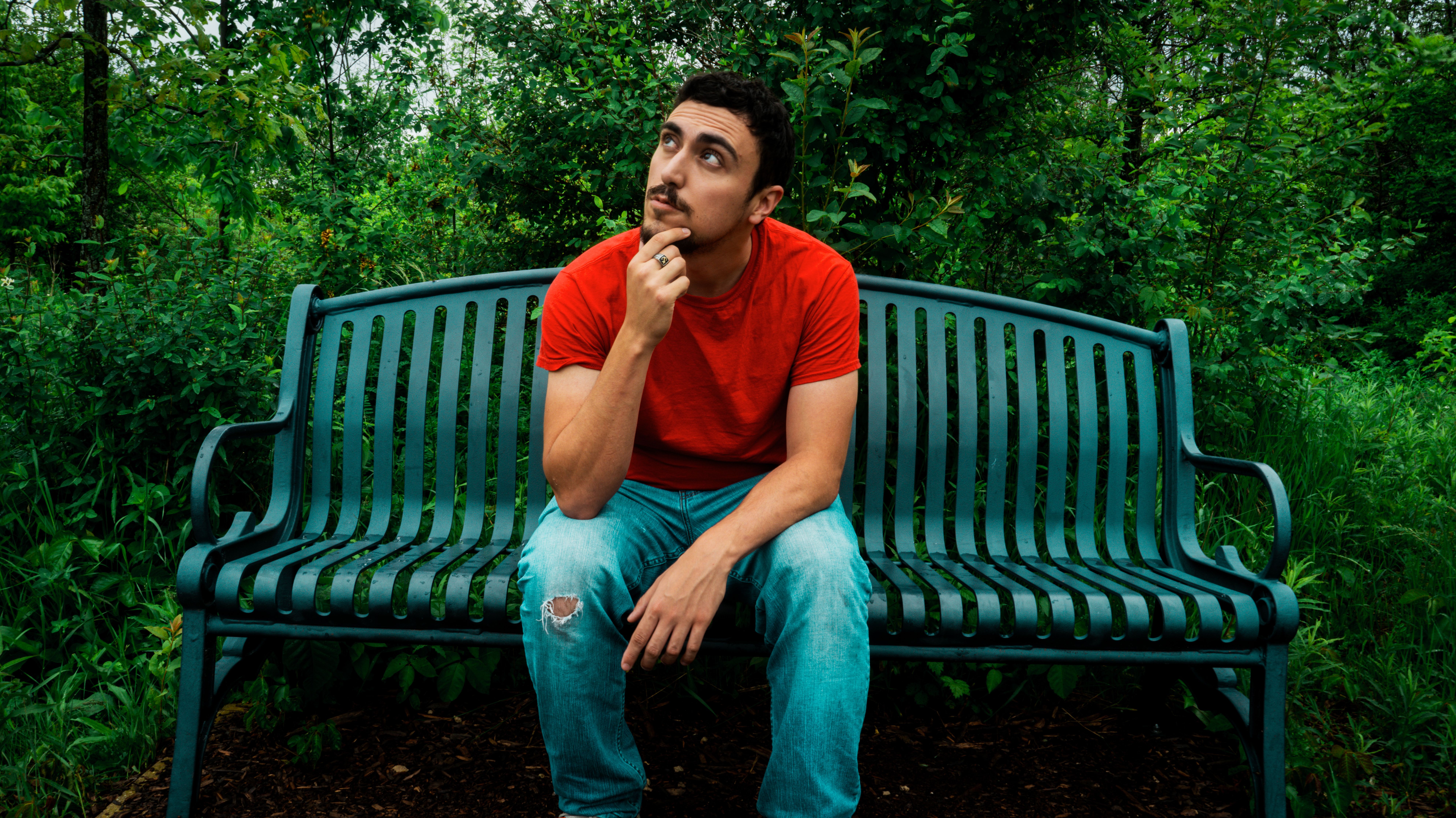 Young Man Sitting on Steel Green Bench in Park · Free Stock Photo
