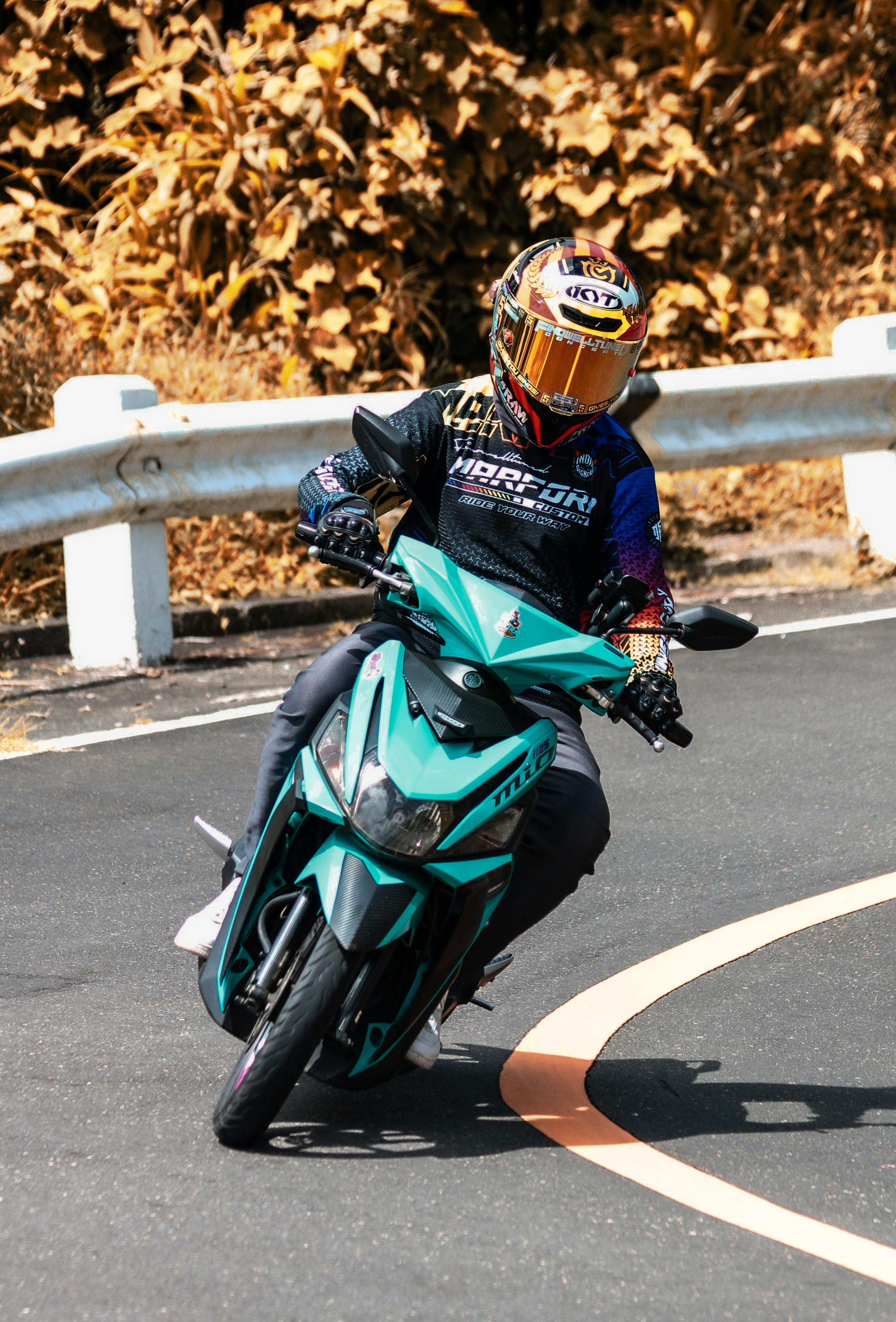 Person Riding Teal Yamaha Mio Motorcycle · Free Stock Photo