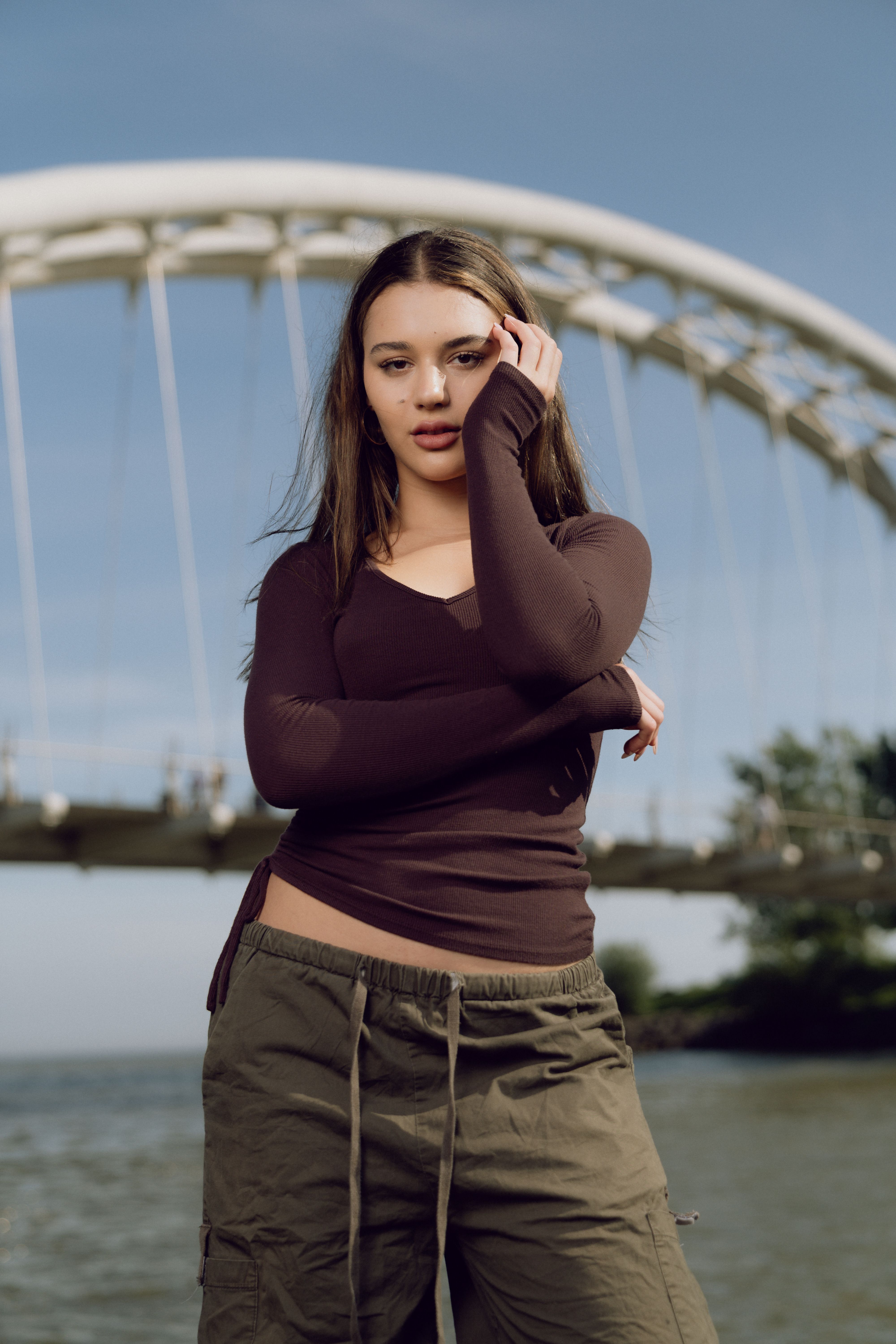 Brunette Woman Posing in Front of Arch Bridge · Free Stock Photo